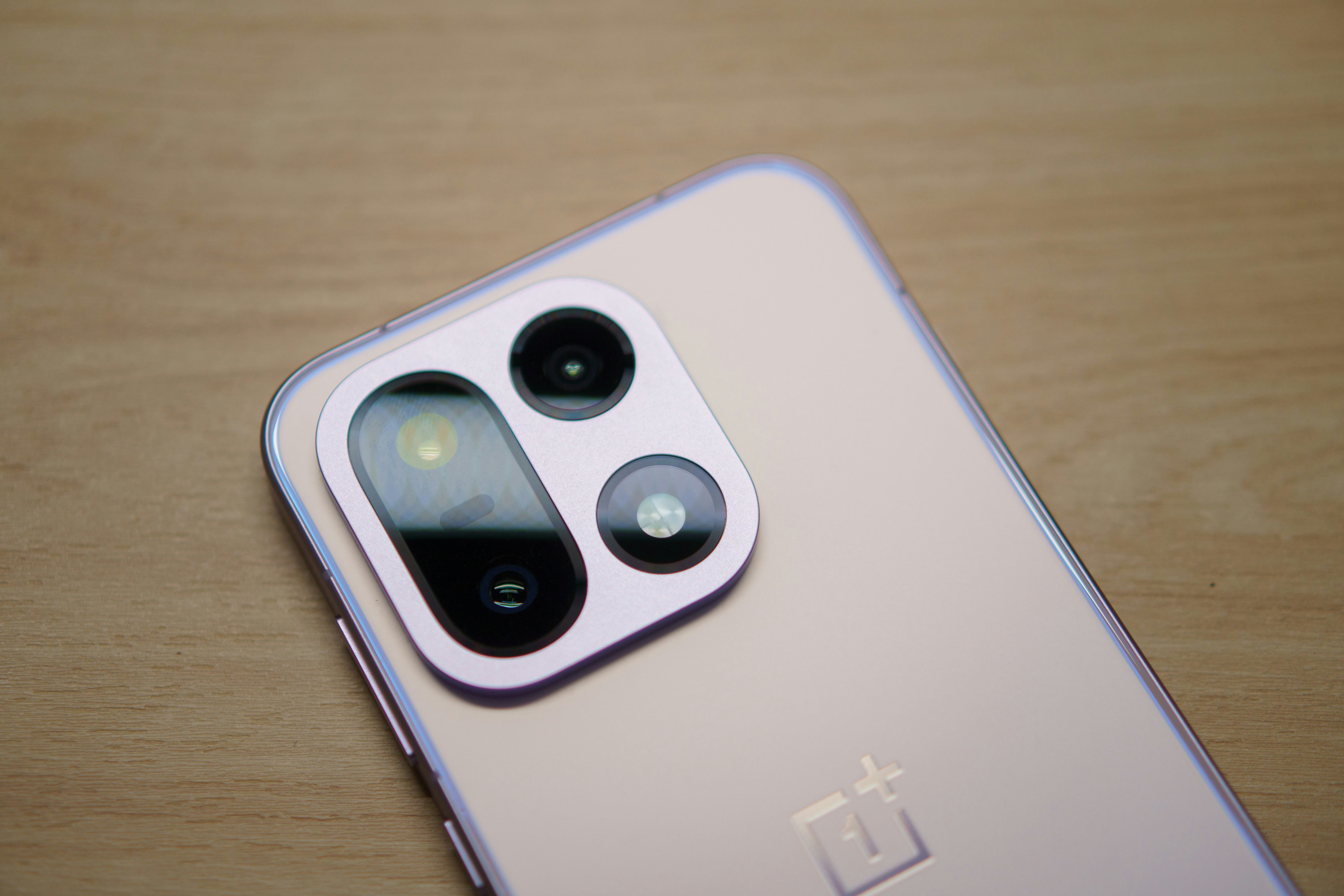 Close-Up of a Modern Smartphone Camera Module on a Wooden Surface