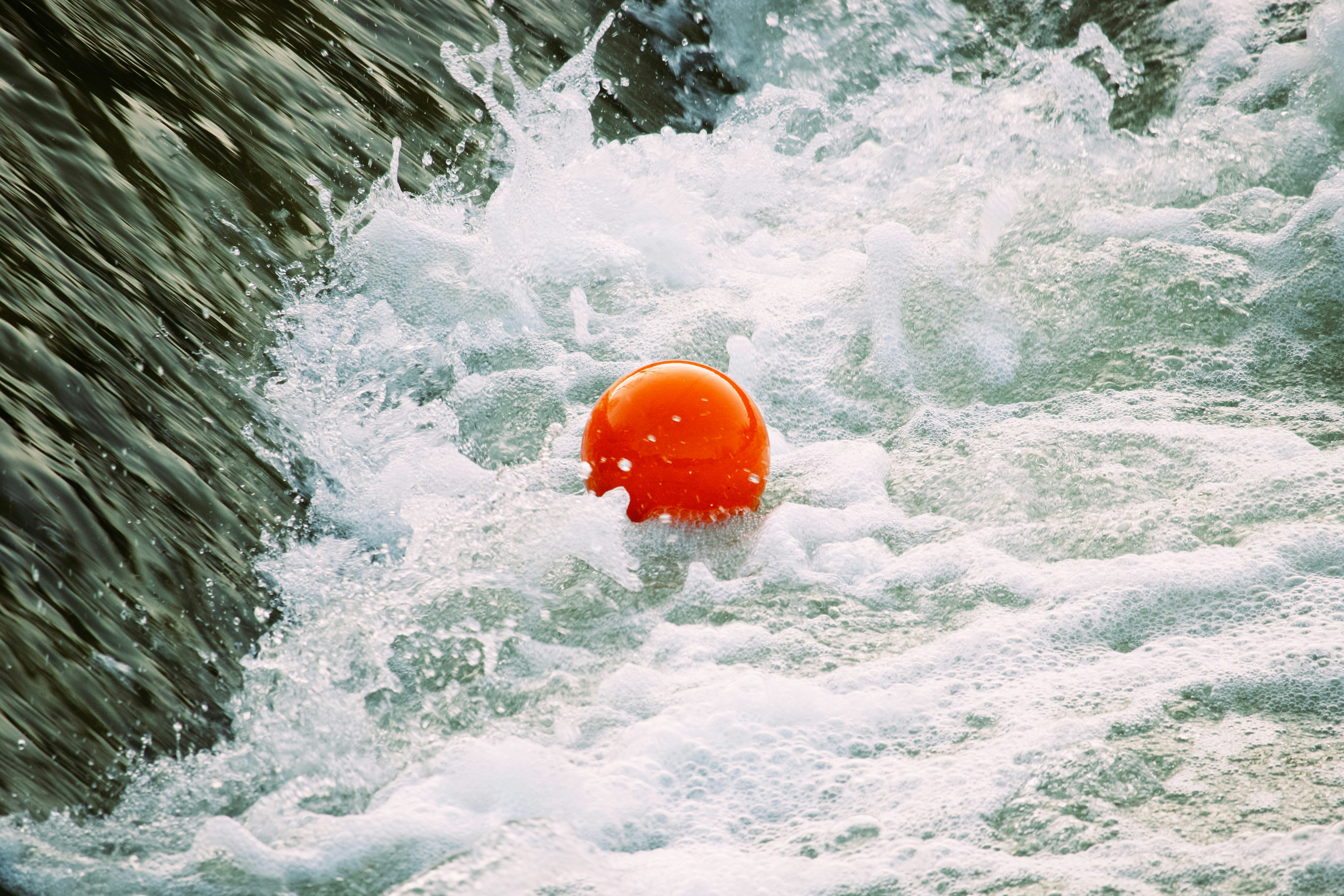 Orange Buoy Breaks the White Tide