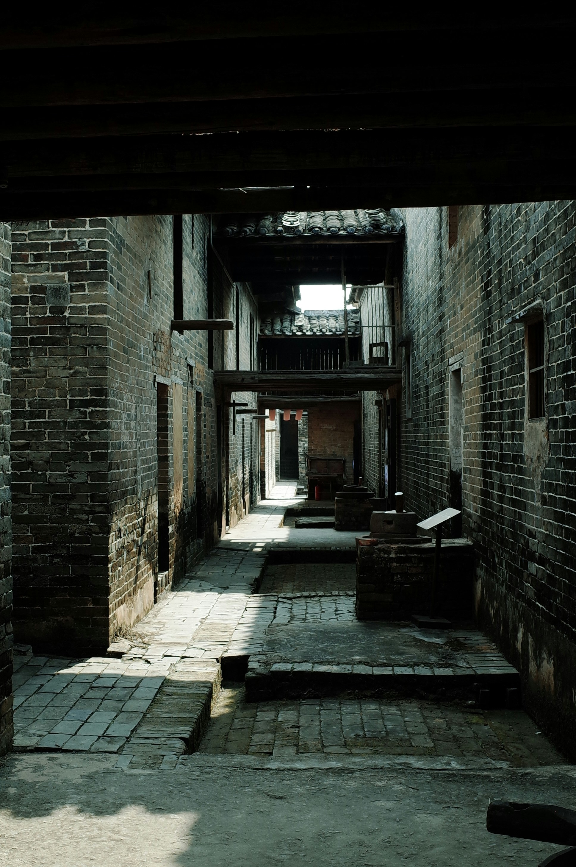 Sunlit Alleyway Through Bricked Corridors