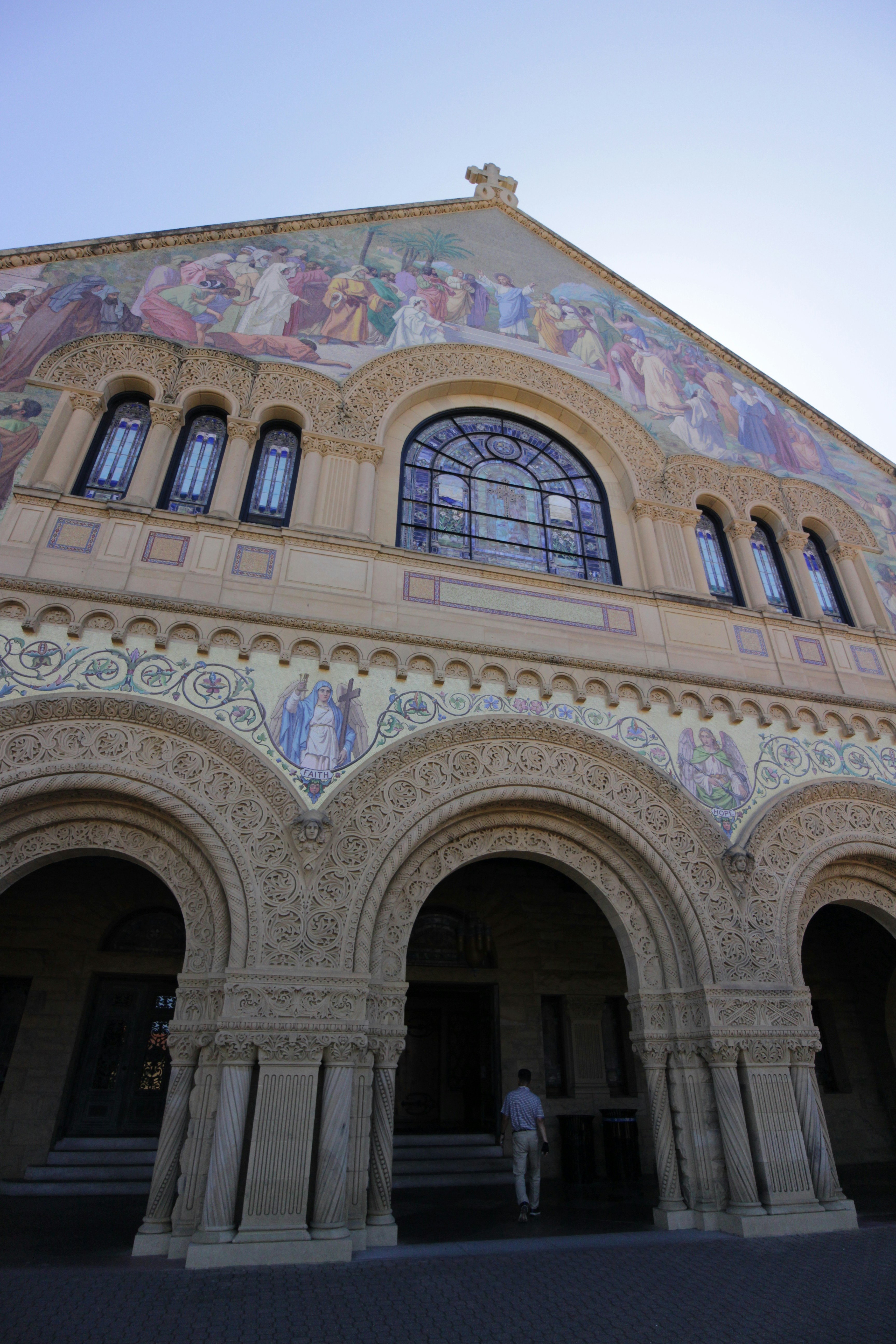Architectural Mosaic: The Facade Crowned by Colored Frescoes and Arched Entrances