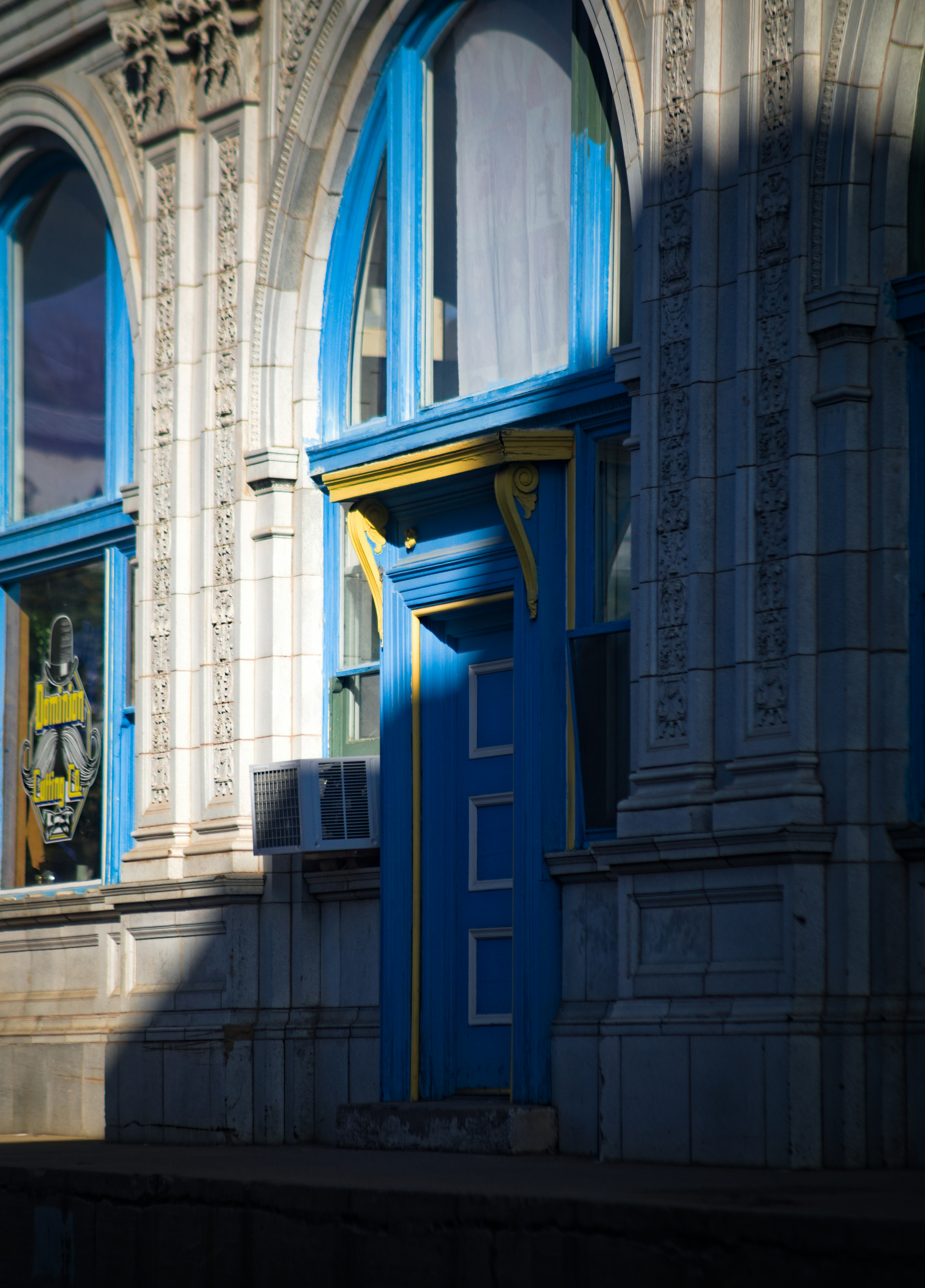 Azure doorways and sunlit details on a historic façade
