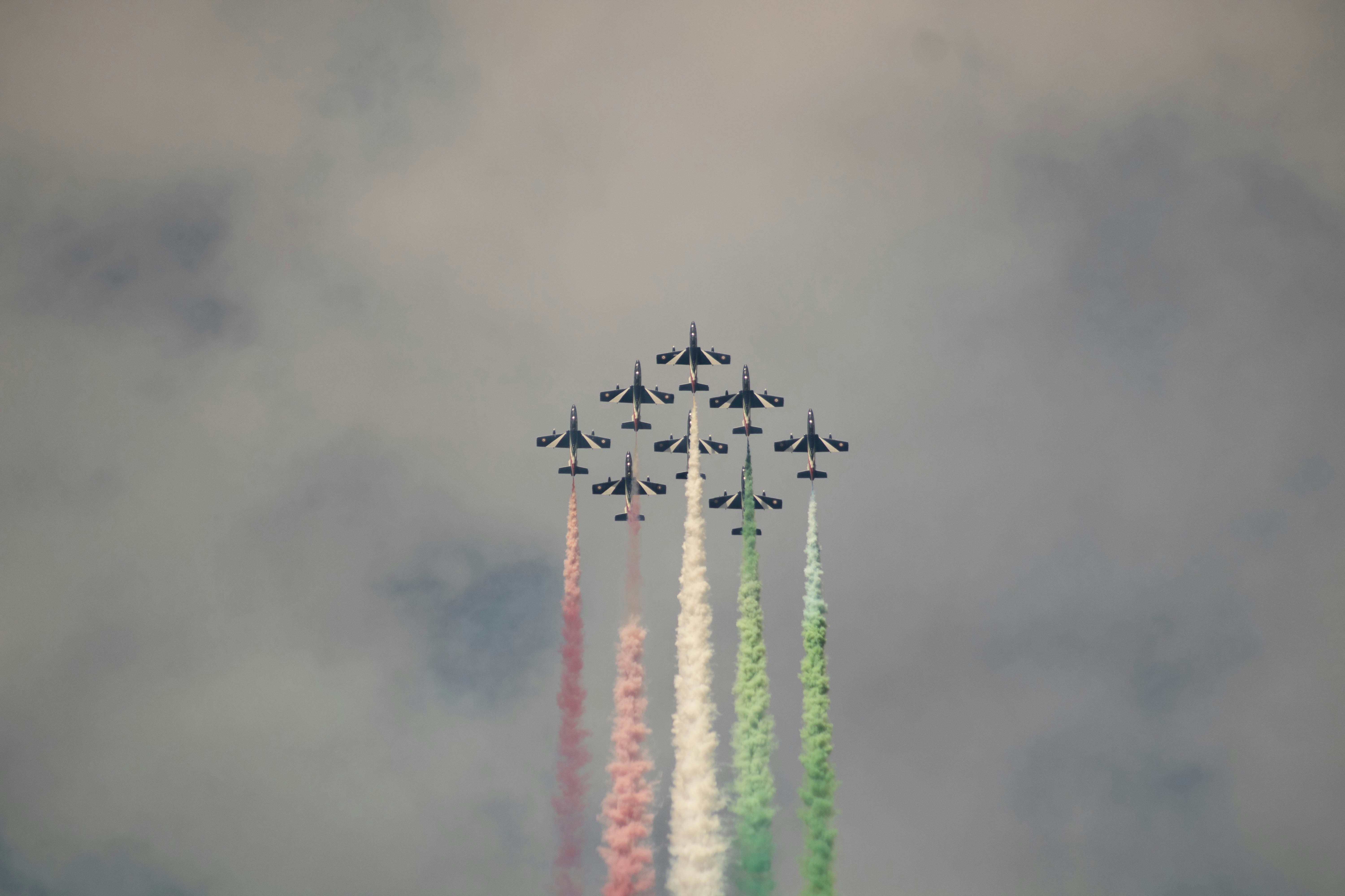 Triumph of Color: Aerial Quartet Escorted by Flag Streams