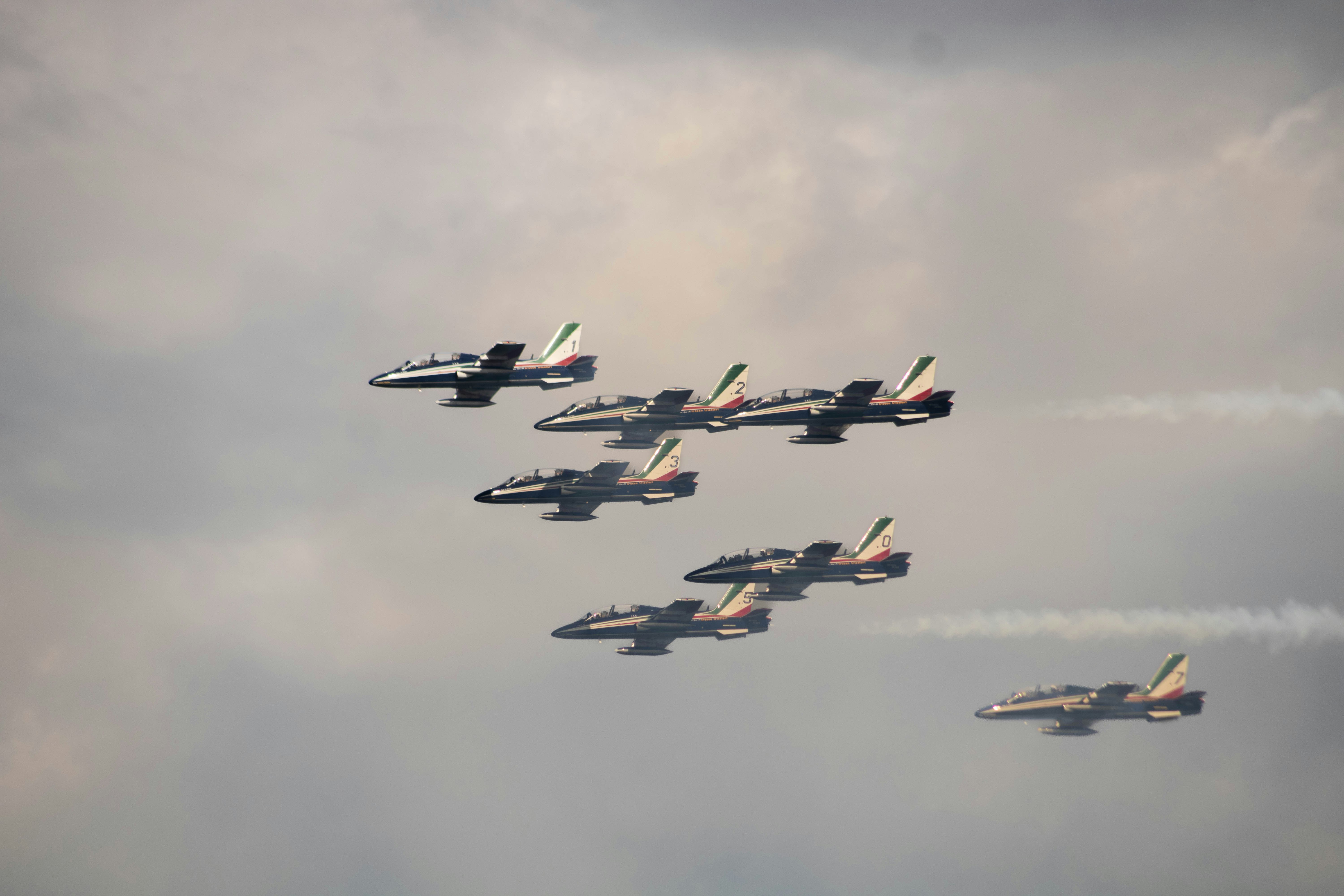 Seven-Trail Formation: Jet Team Pierces a Clouded Sky