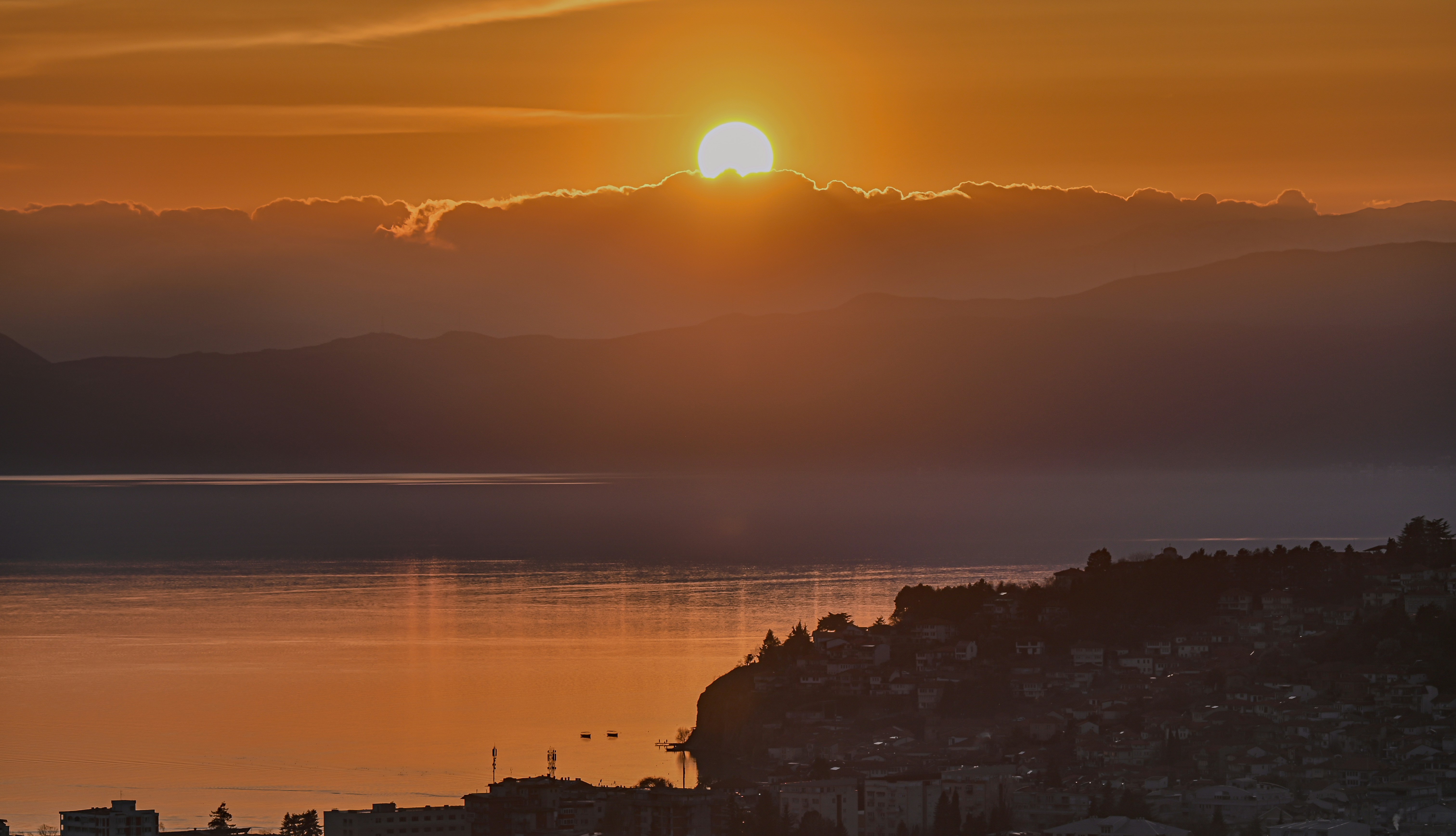 Sunlit Crest: The Golden Hour Over a Quiet Coastal Town