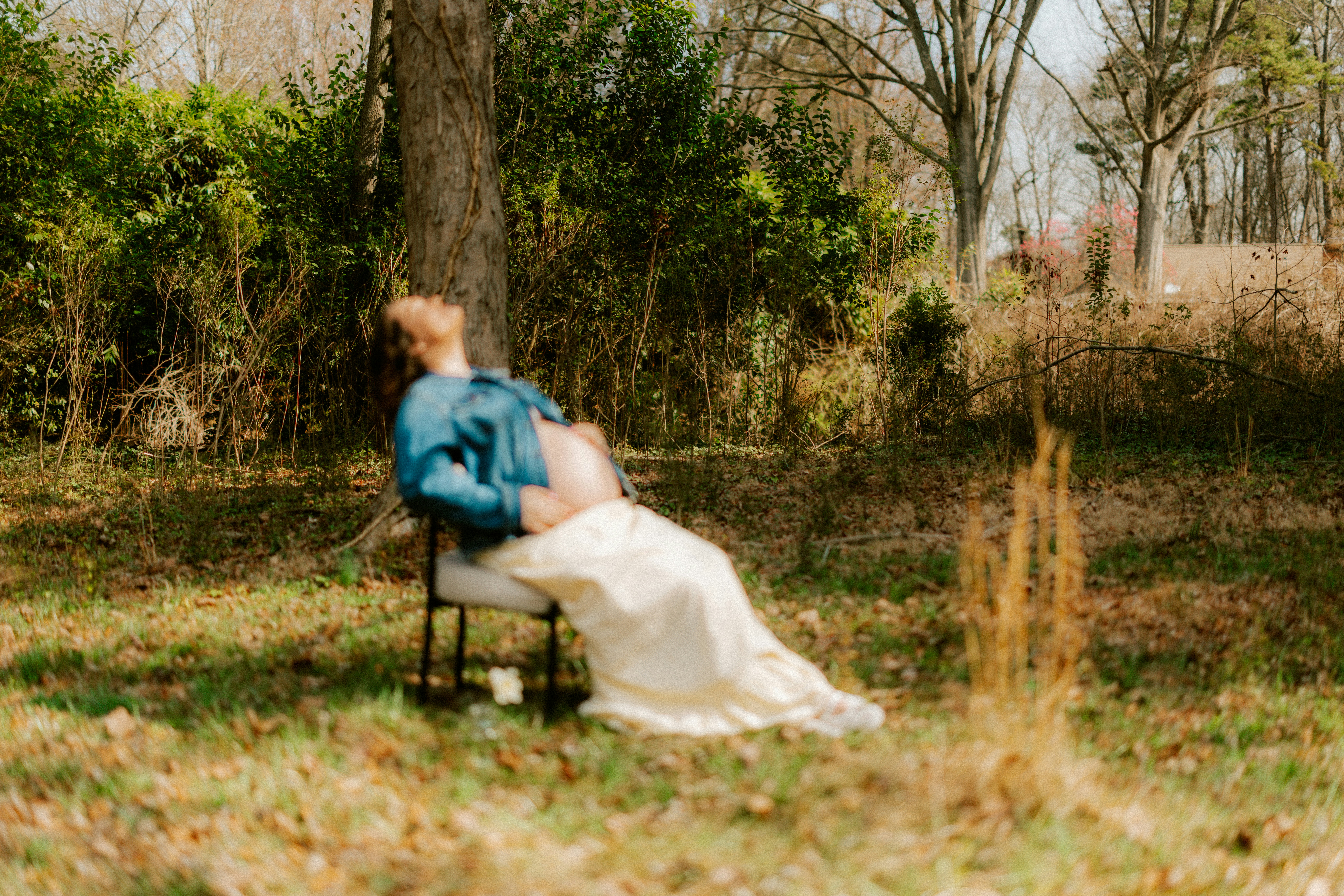 Relaxed Portrait of a Seated Bride in a Sunlit Park