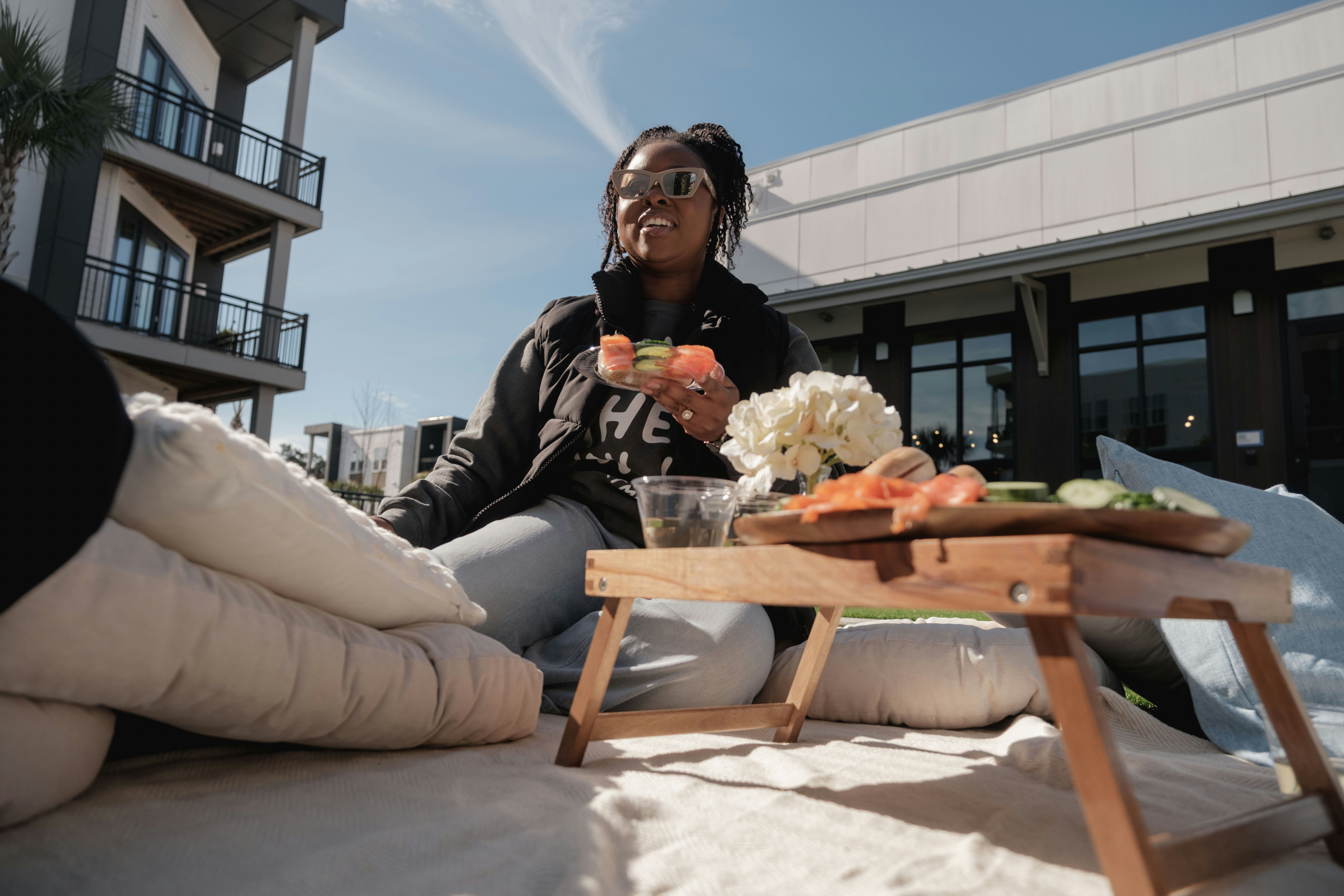Picnic on a rooftop: friend with citrus-infused treats under a blue sky