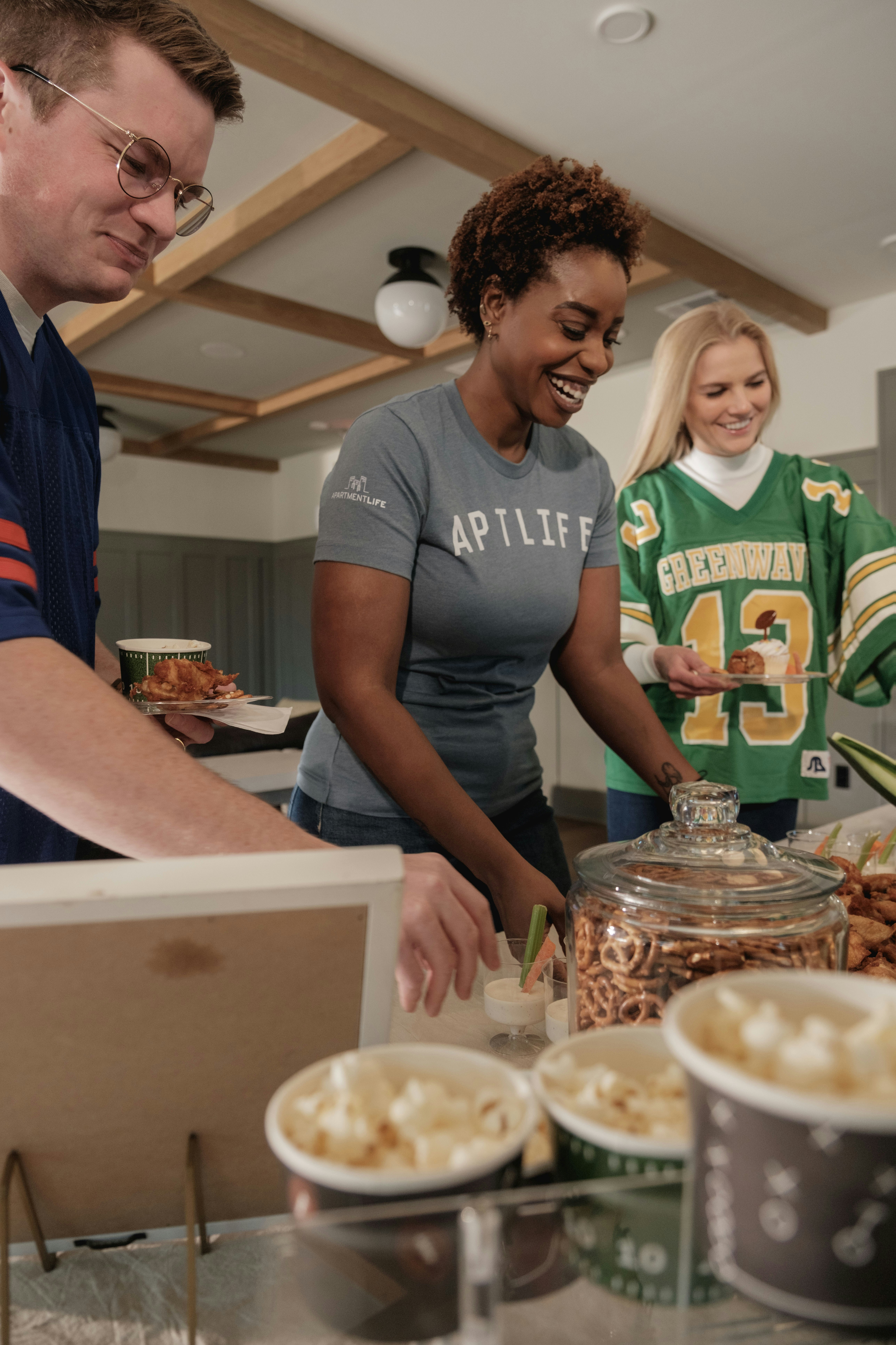 Smiling volunteers line up treats at a casual gathering