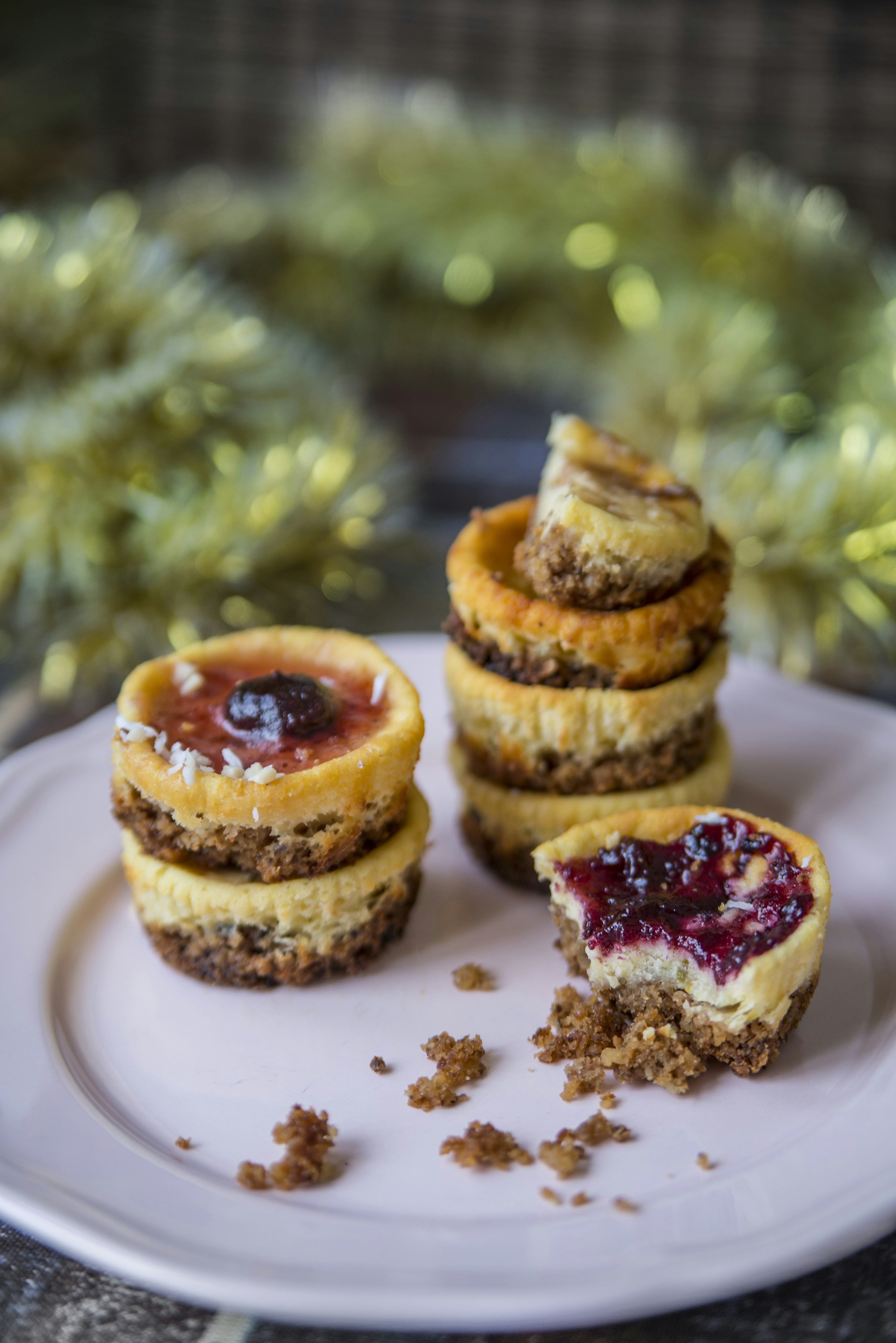 Stacked Pastry Treasures: A Trio of Mini Linzer Cakes on a White Plate