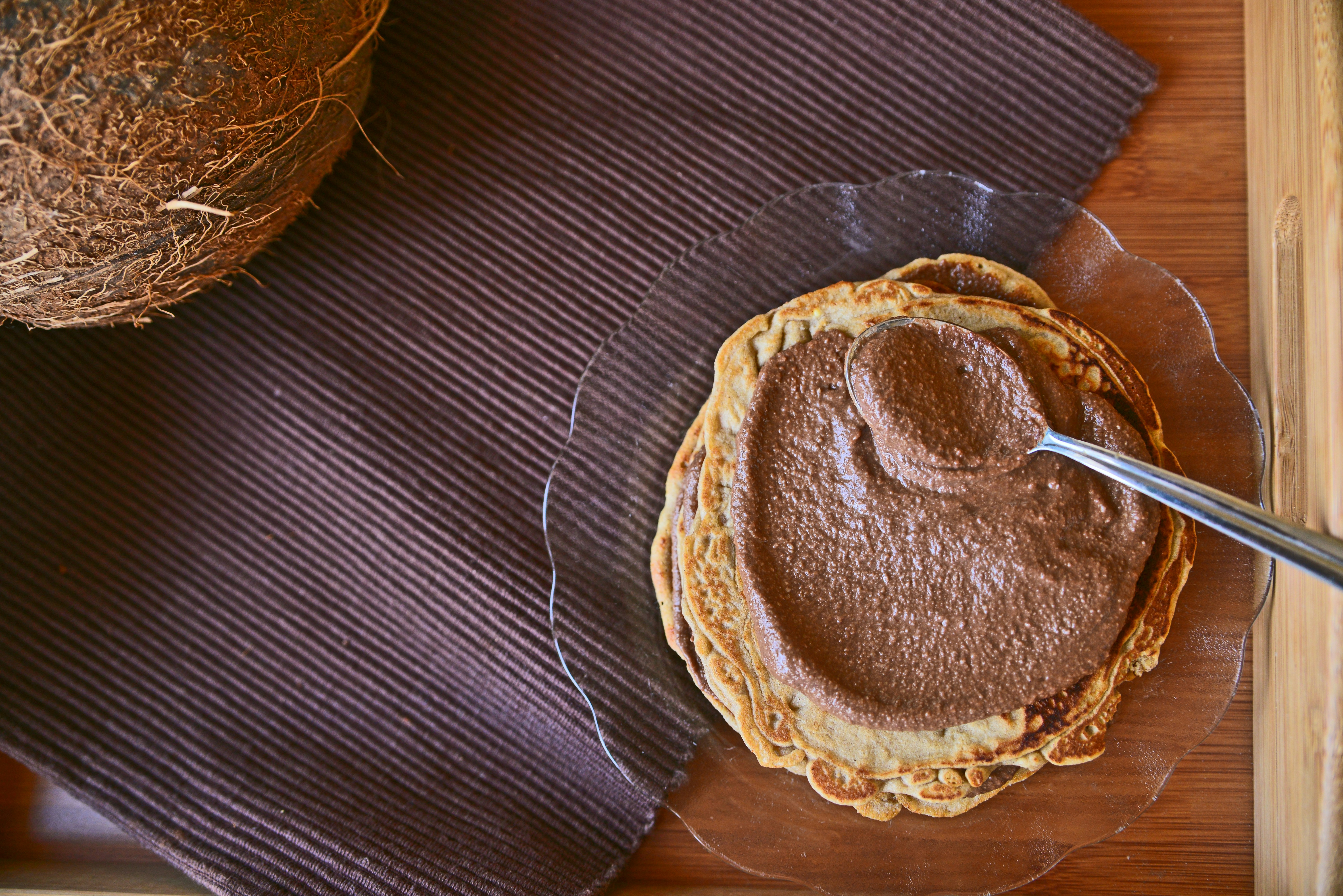 Cocoa-topped tart resting beside a textured napkin
