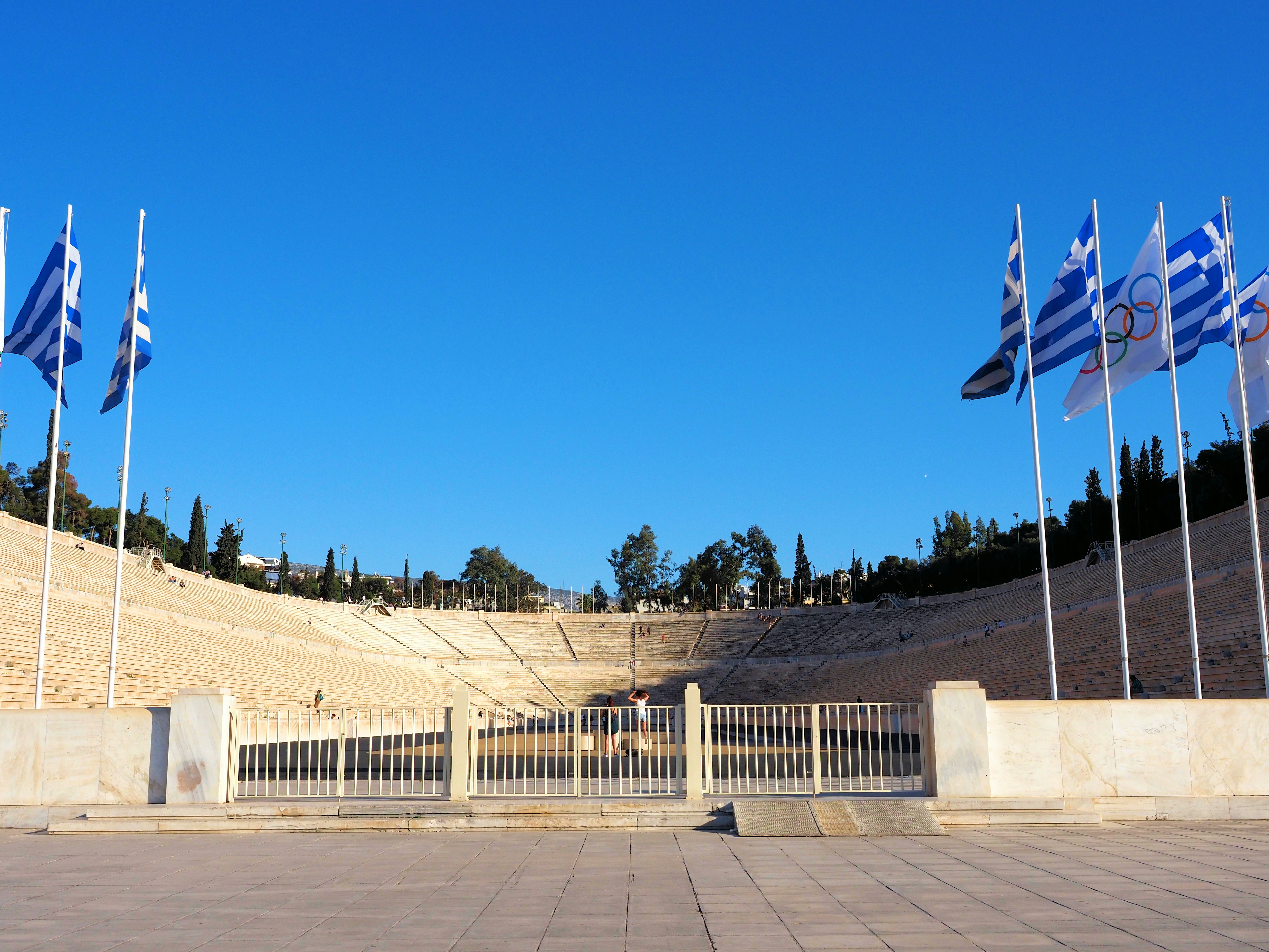 Flag-lined Arena Beneath a Clear Blue Sky