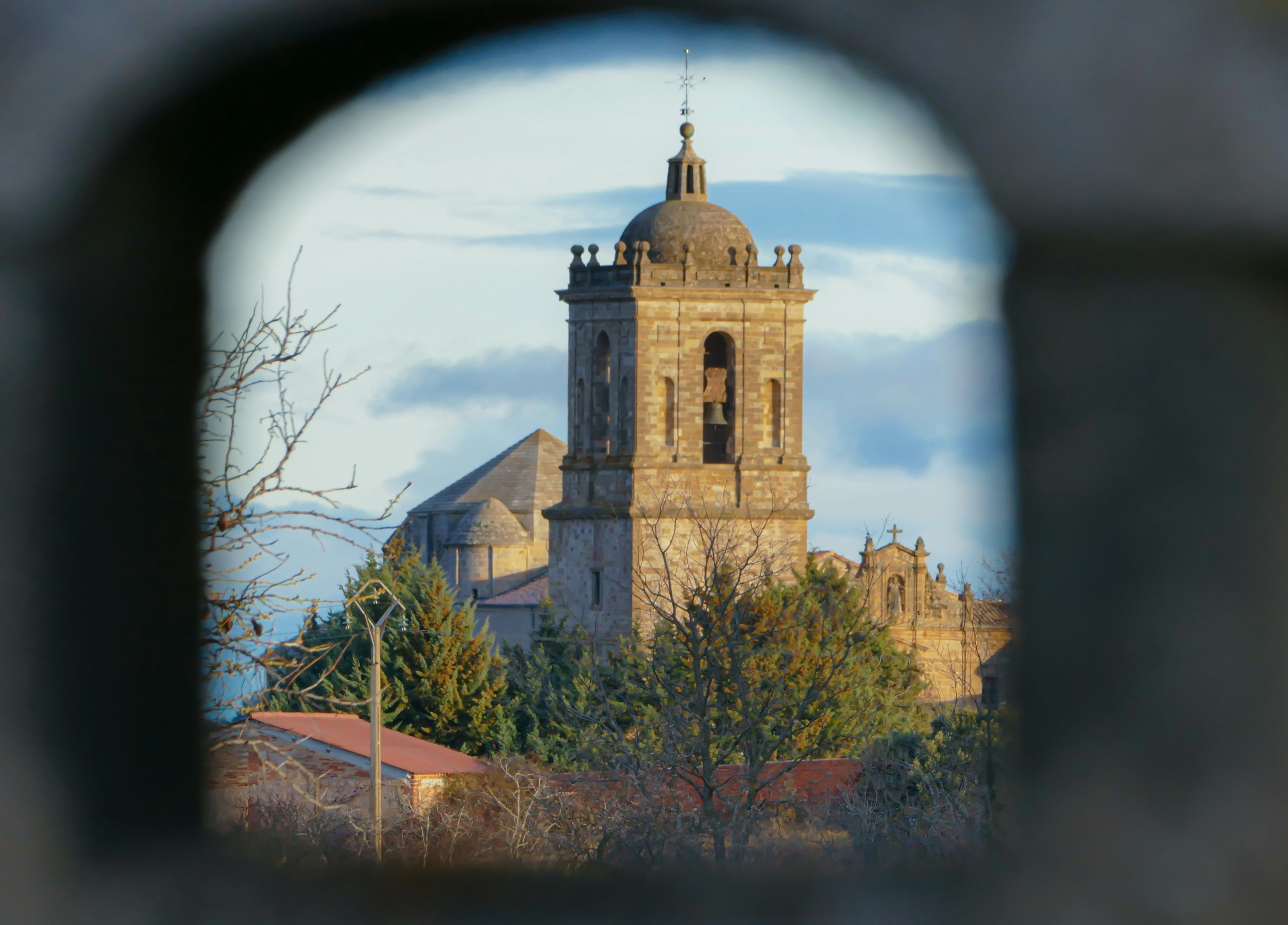 Bell Tower in Focus: Stone Church Framed by Arch