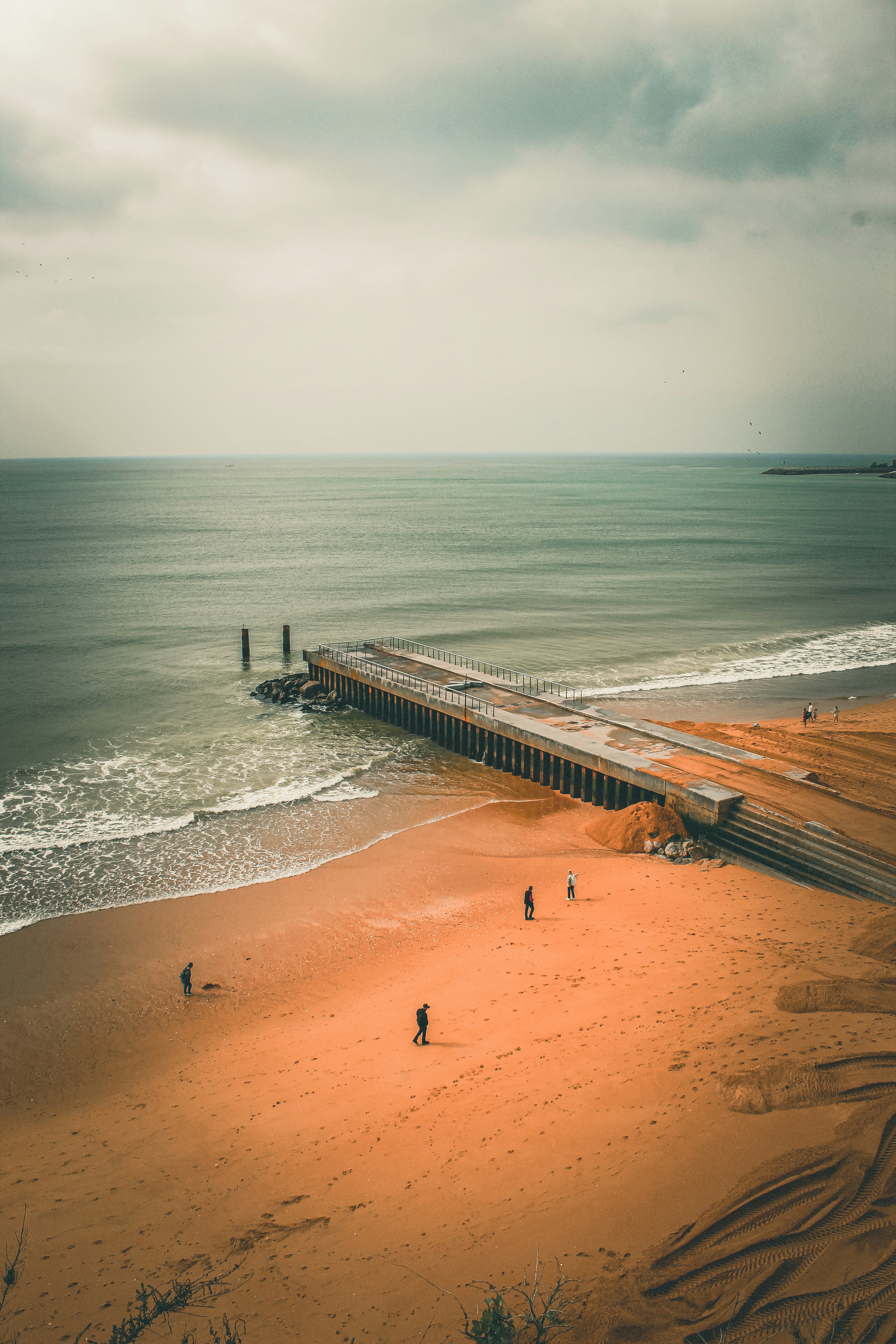 Orange Shoreline Agenda: Figures on a Distant Pier