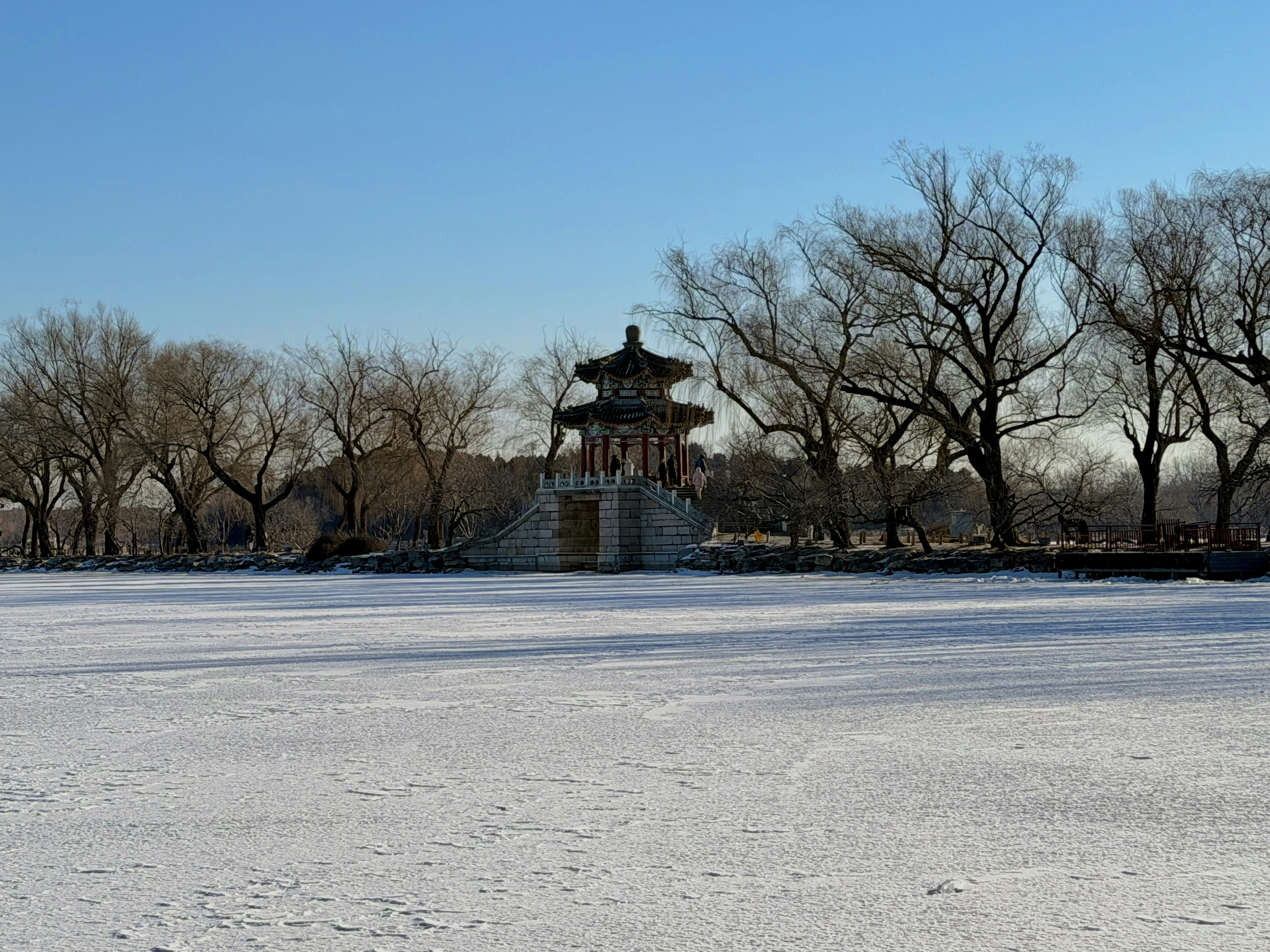 Winter Pavilion: A Quiet Snow-Blanketed Moment by the Park