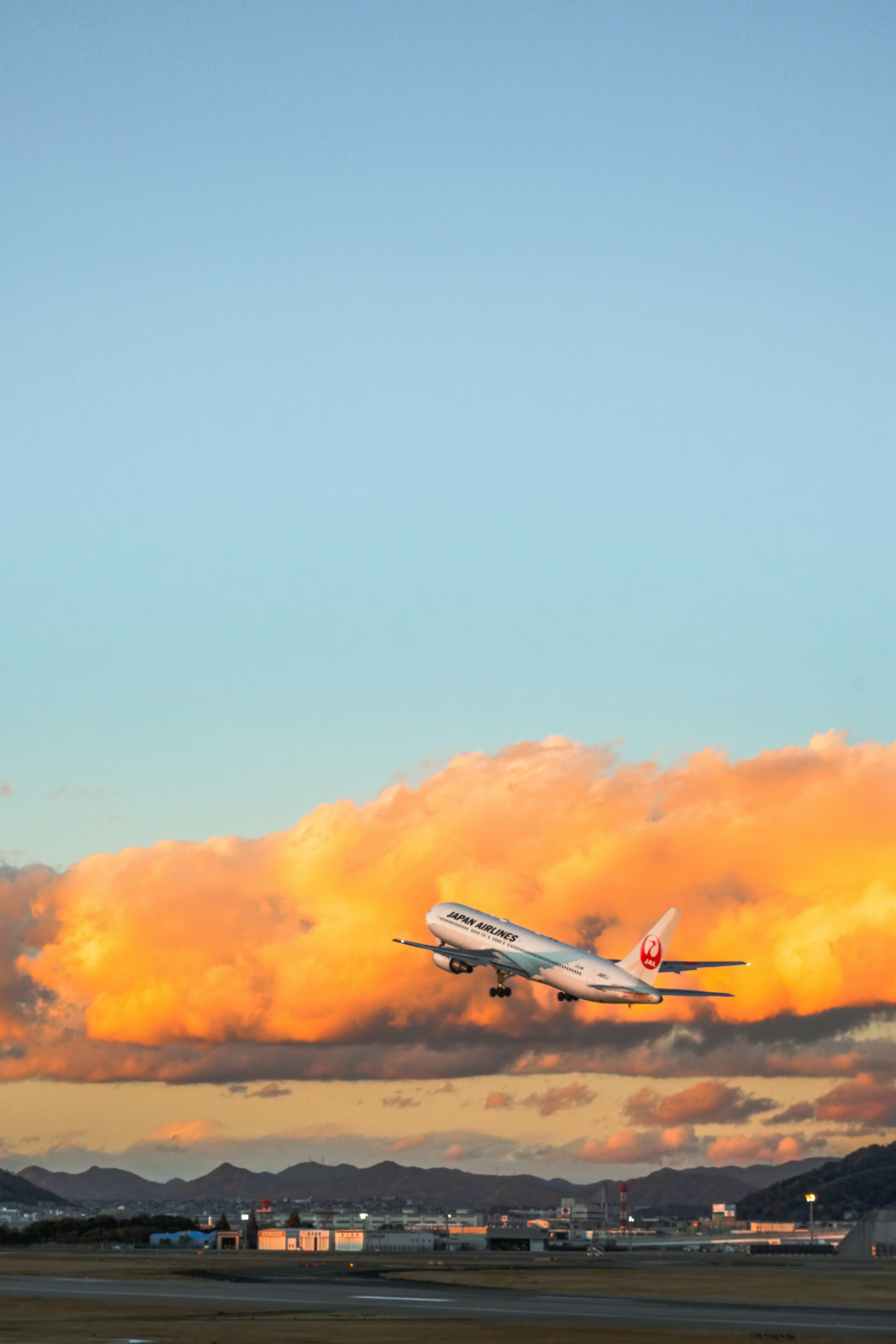 Sunlit Takeoff: A Jumbo Pierces the Orange Cloudscape