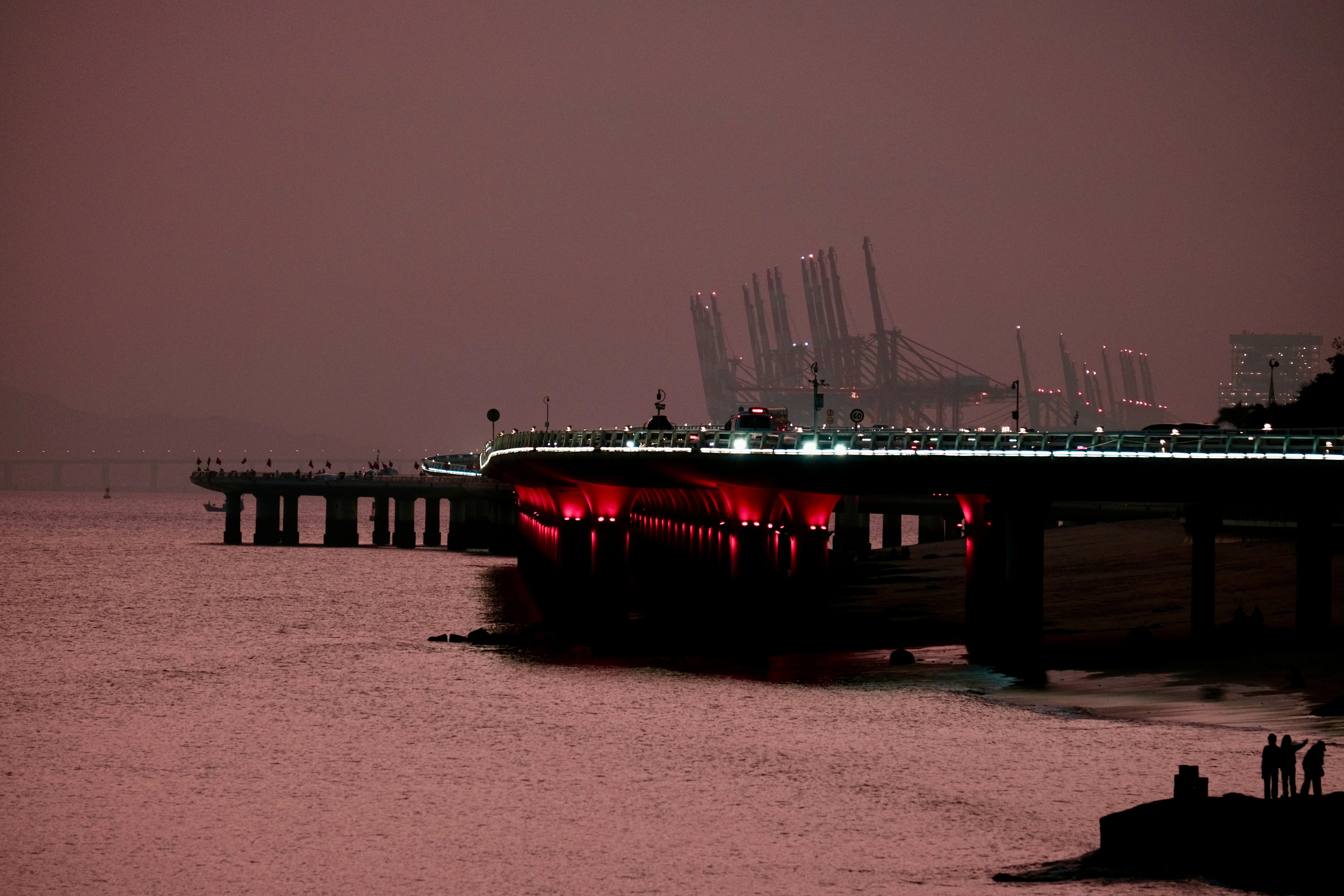 Red-lit Pier: A Quiet Atlantic Silhouette at Dusk