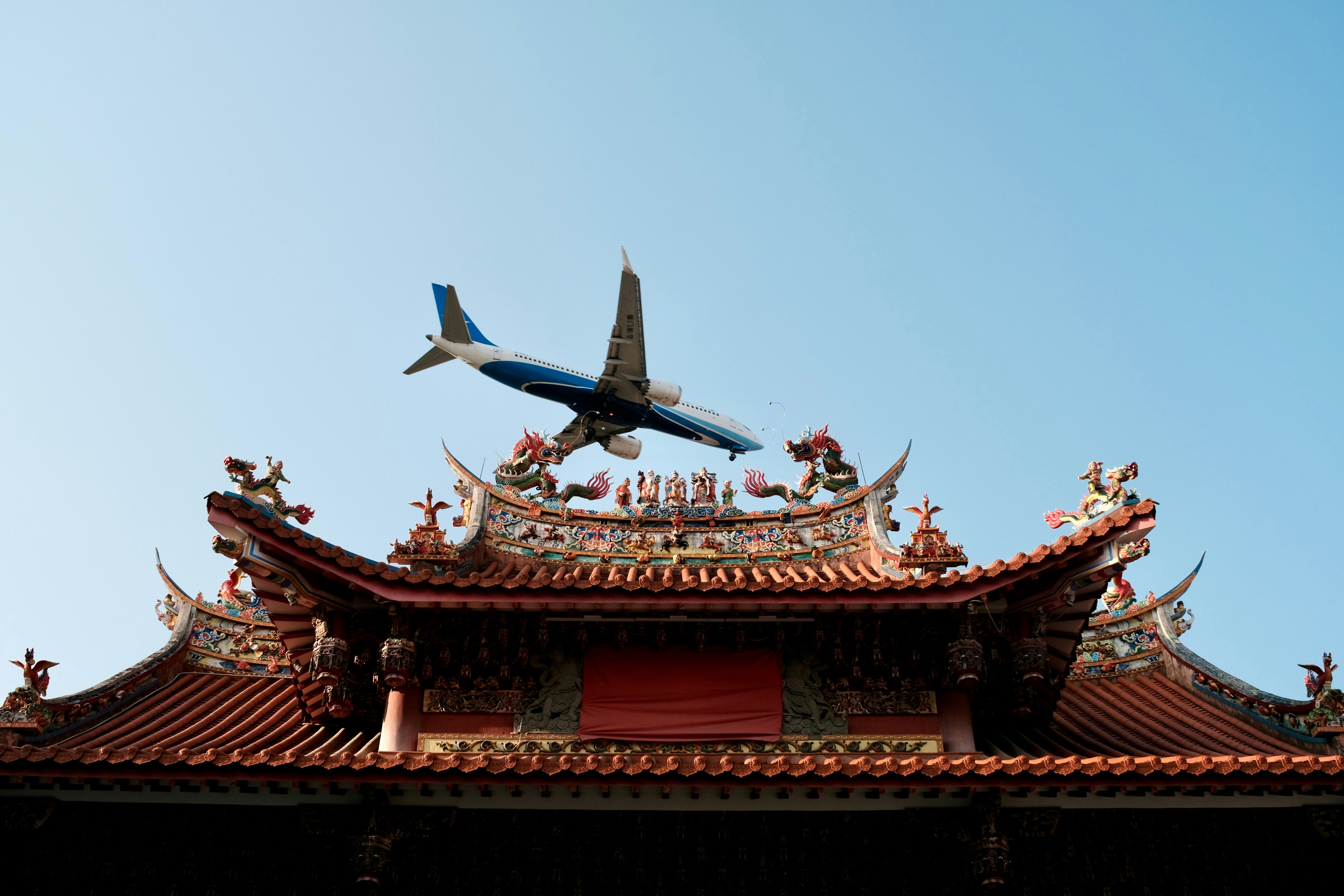 Skyward Ascent over the Carved Rooflines