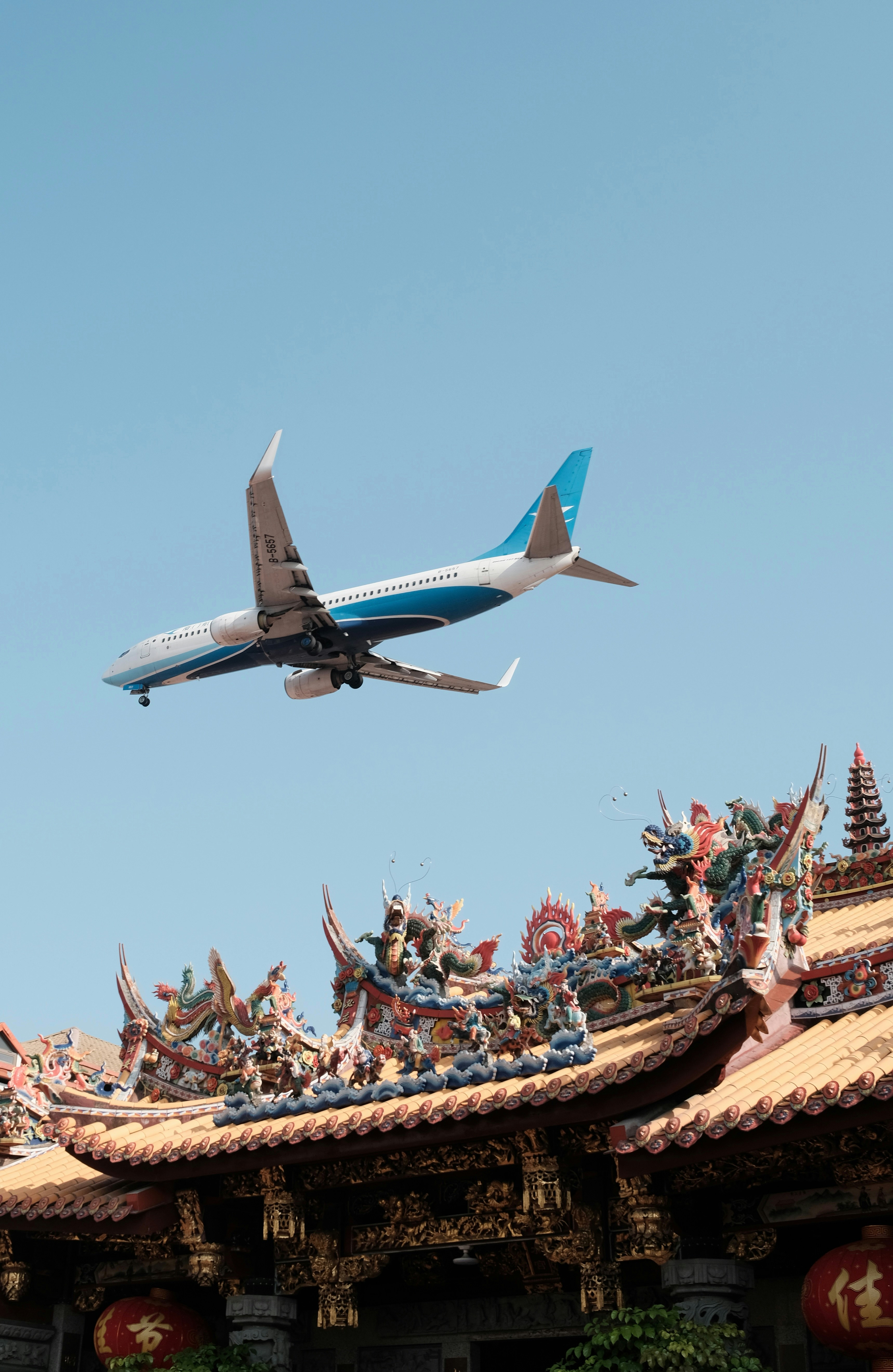 Ascending skyward: a city temple greets a departing airliner