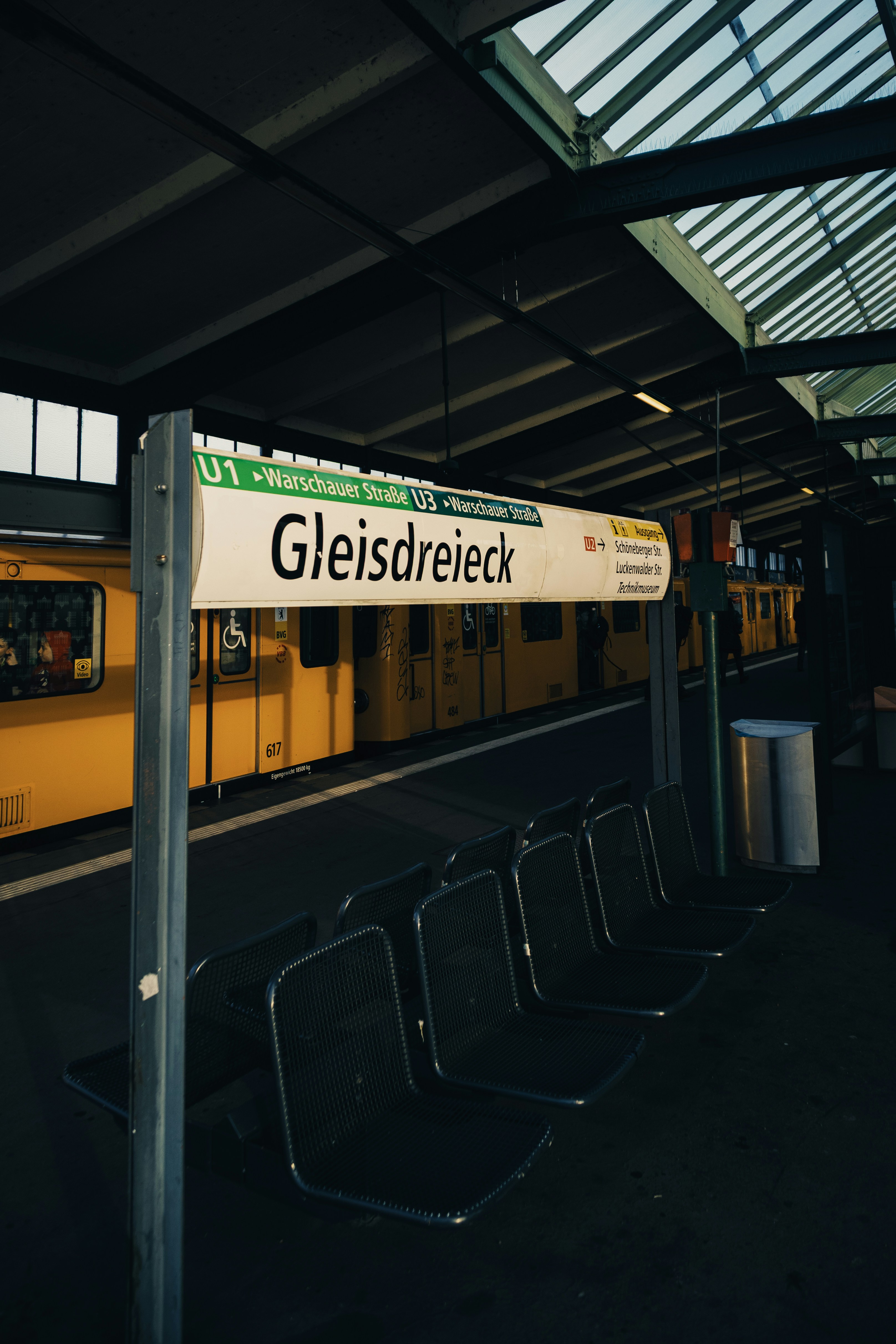 Gleisdreieck Platform: Neon Yellow Trains Under a Glass Canopy
