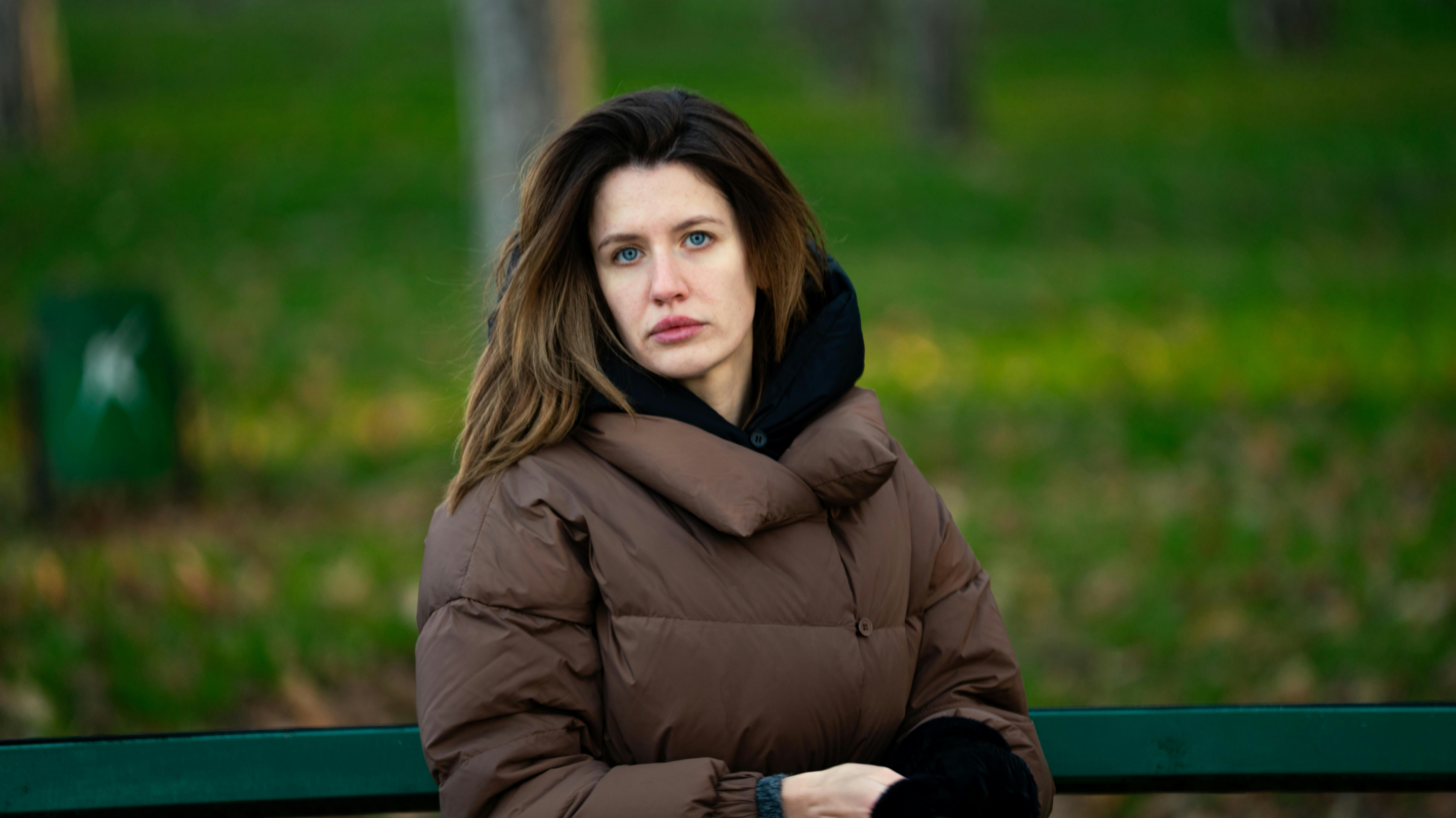 Coat And Quiet Gaze on a Park Bench