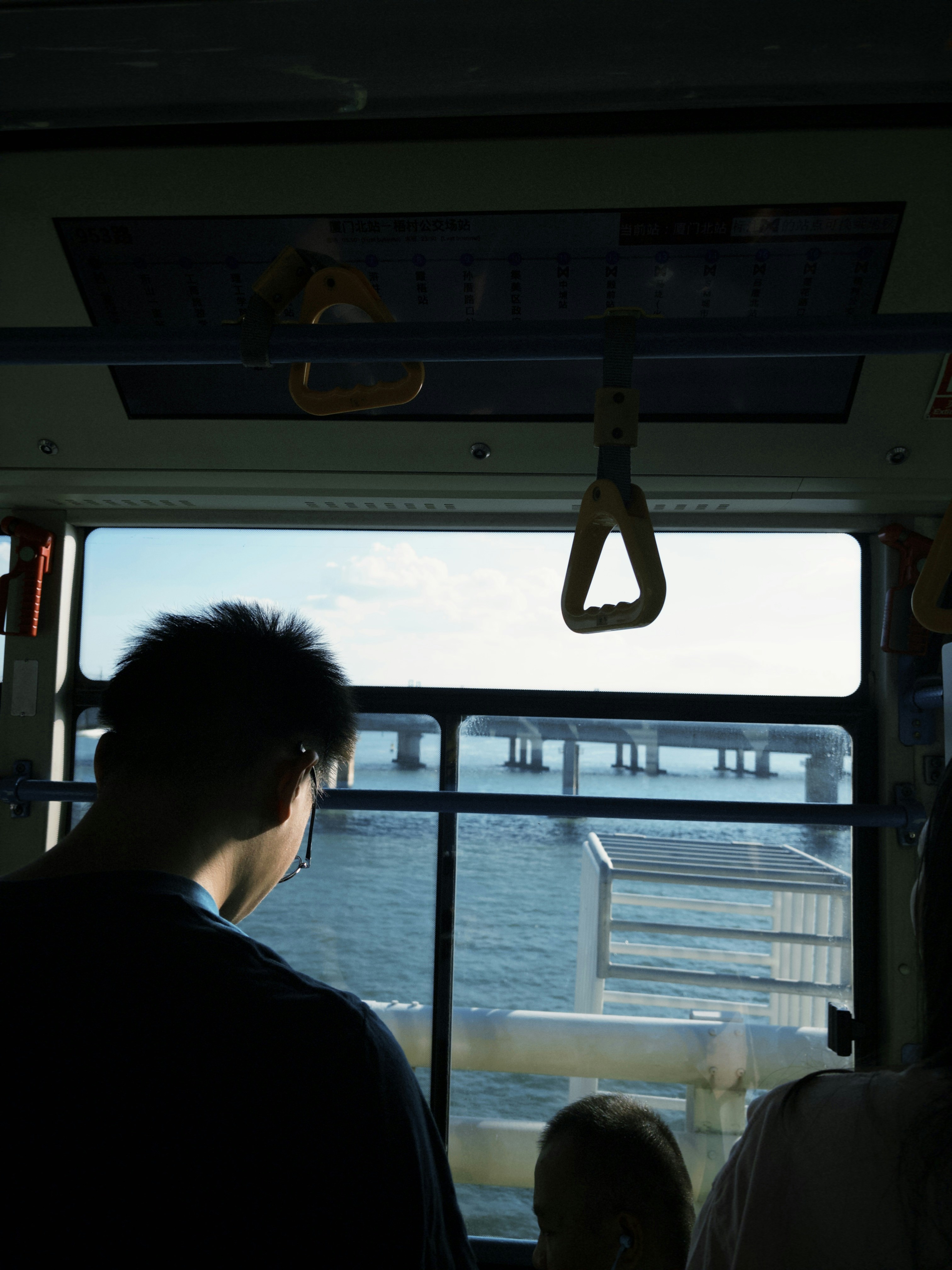  commuters at the harbor: silhouettes against a windowed sea view 