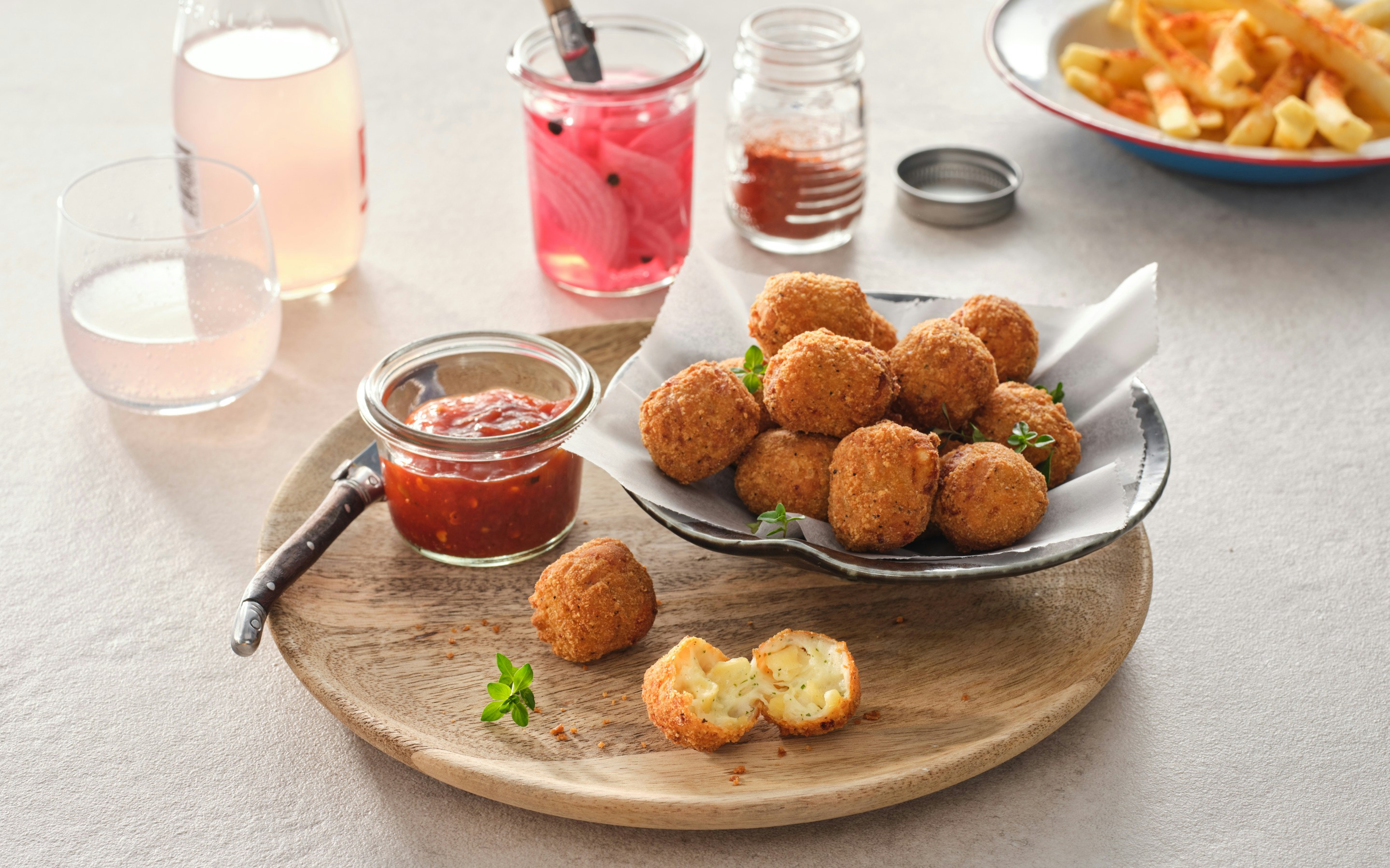 Crispy Afro-Fried Bites with Dipping Sauce on a Rustic Board