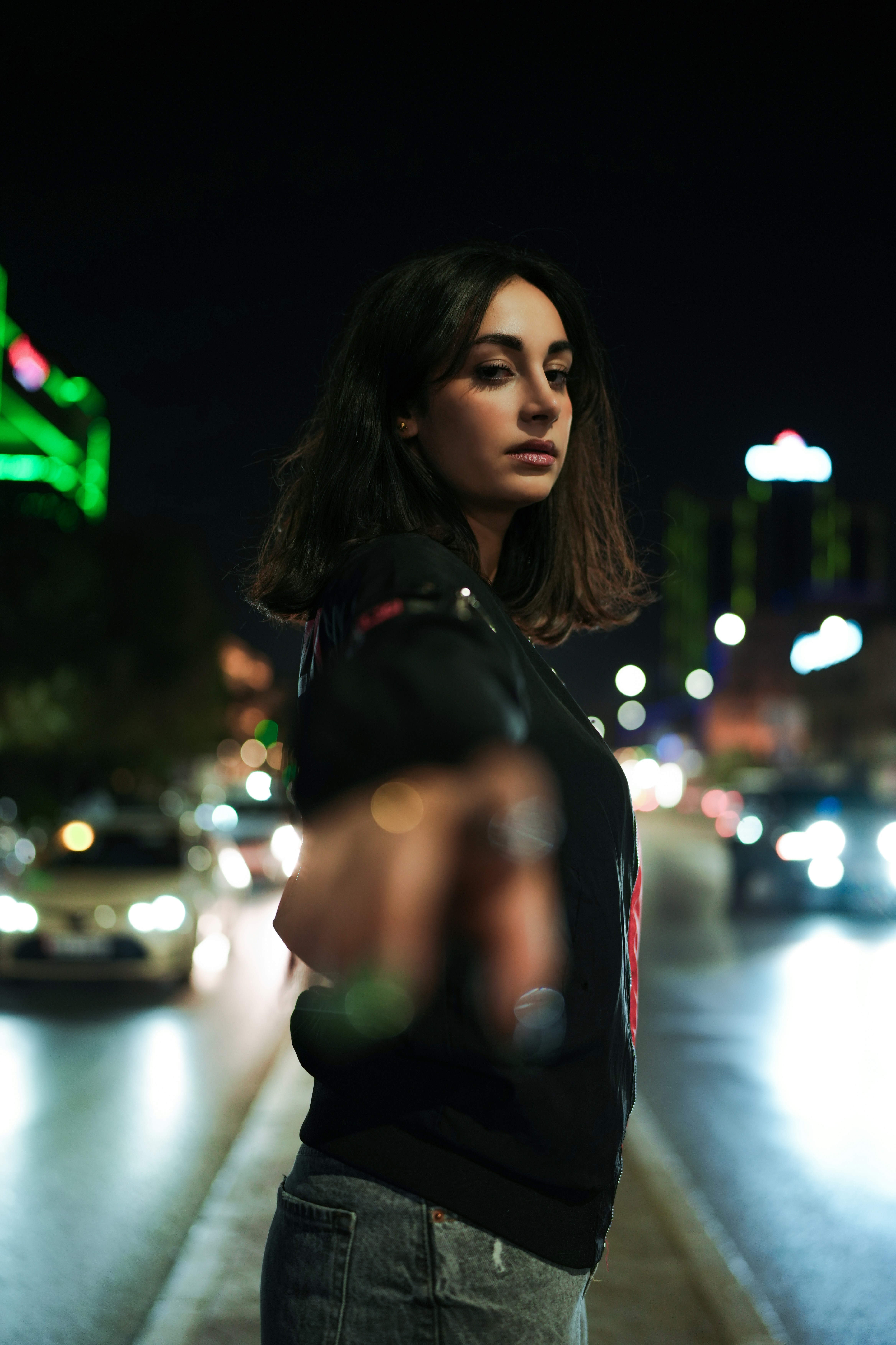 Night Street Portrait: A Woman in Focus Amid Neon Bokeh