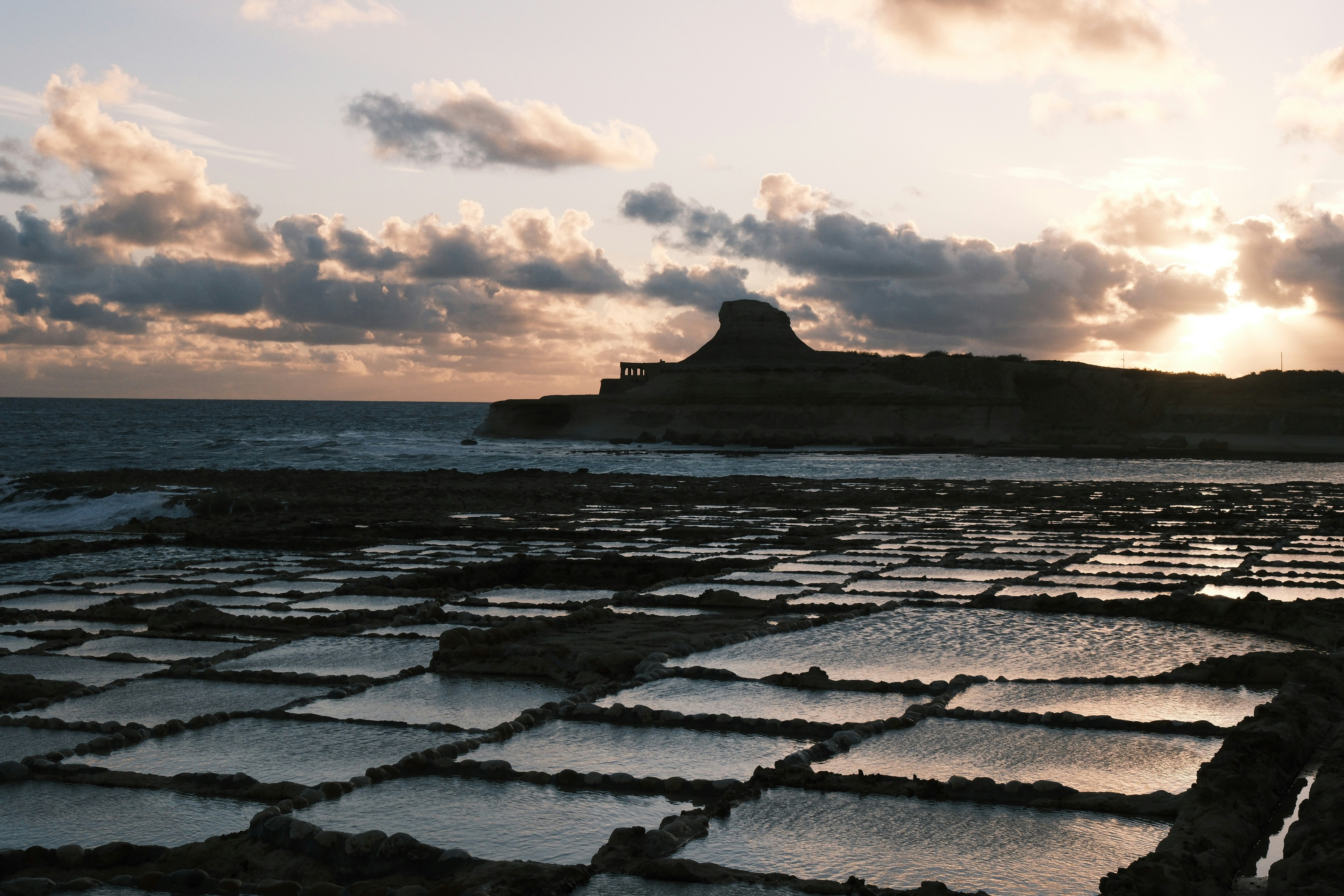 Sunset Over Terraced Rocks: A Quiet Coastline at Dusk