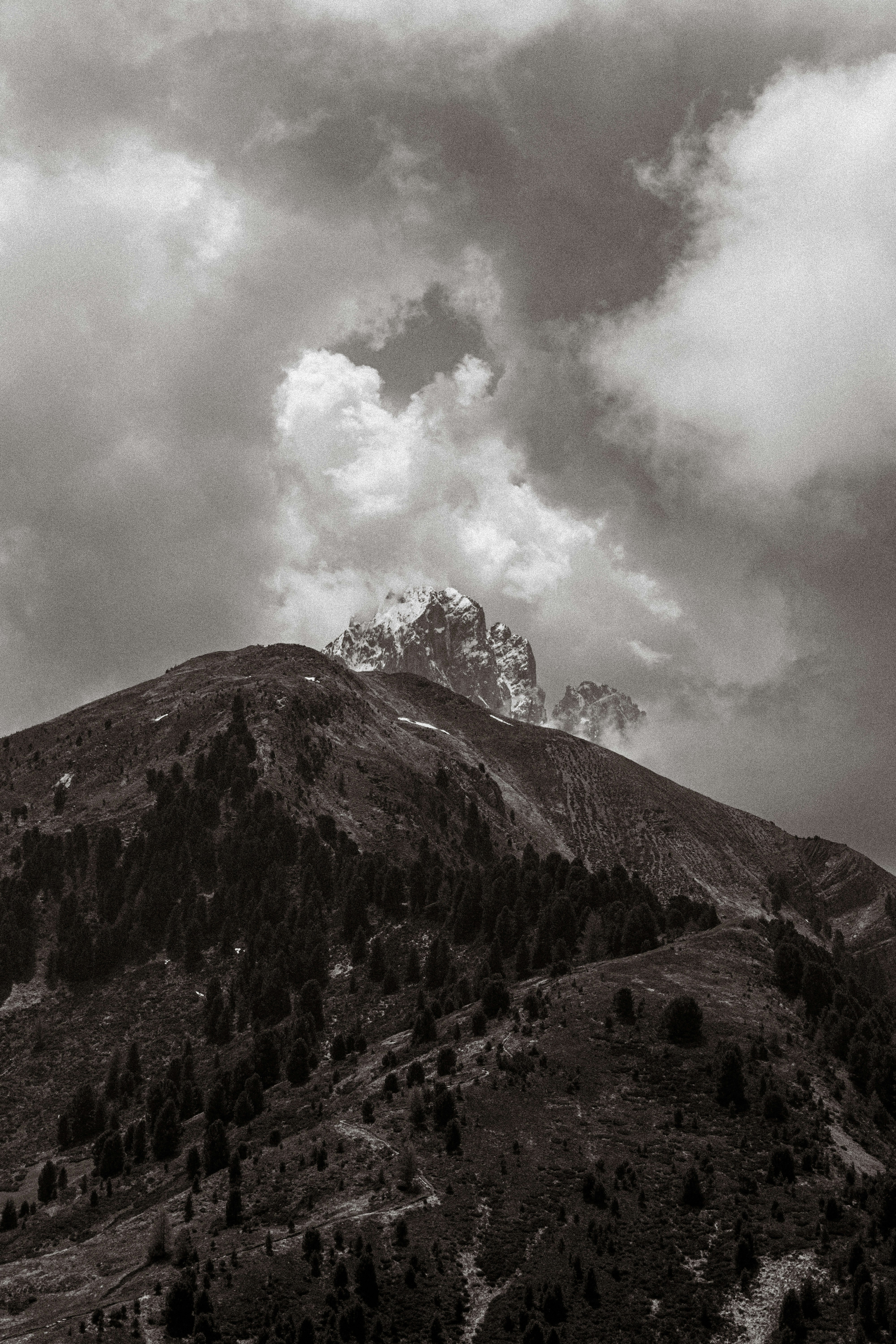 Cloud-licked Peak: A Lone Mountain Crowned by Storm