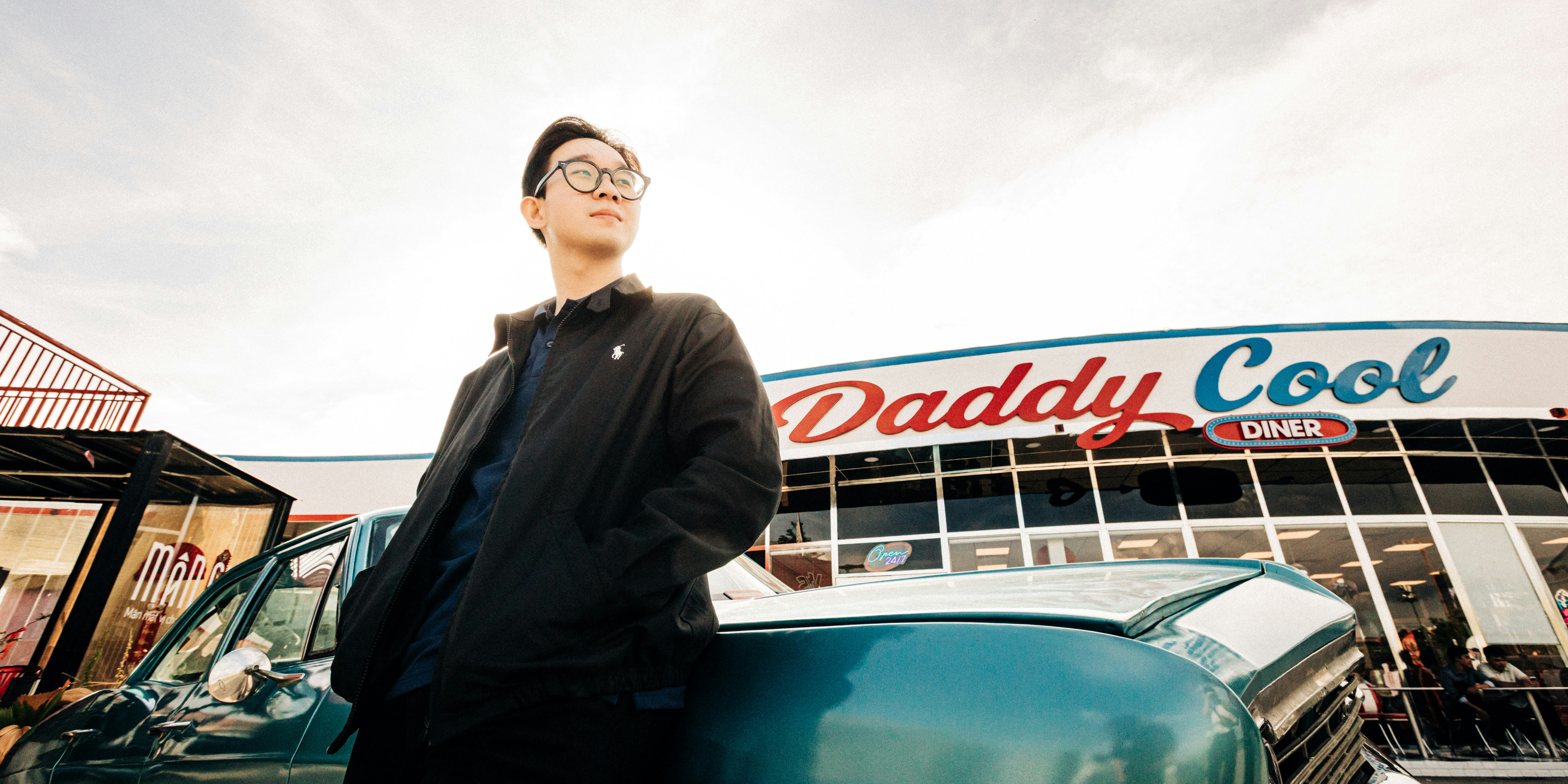 Portrait in Front of a Retro Diner: A Quiet Confidence by Daddy Cool