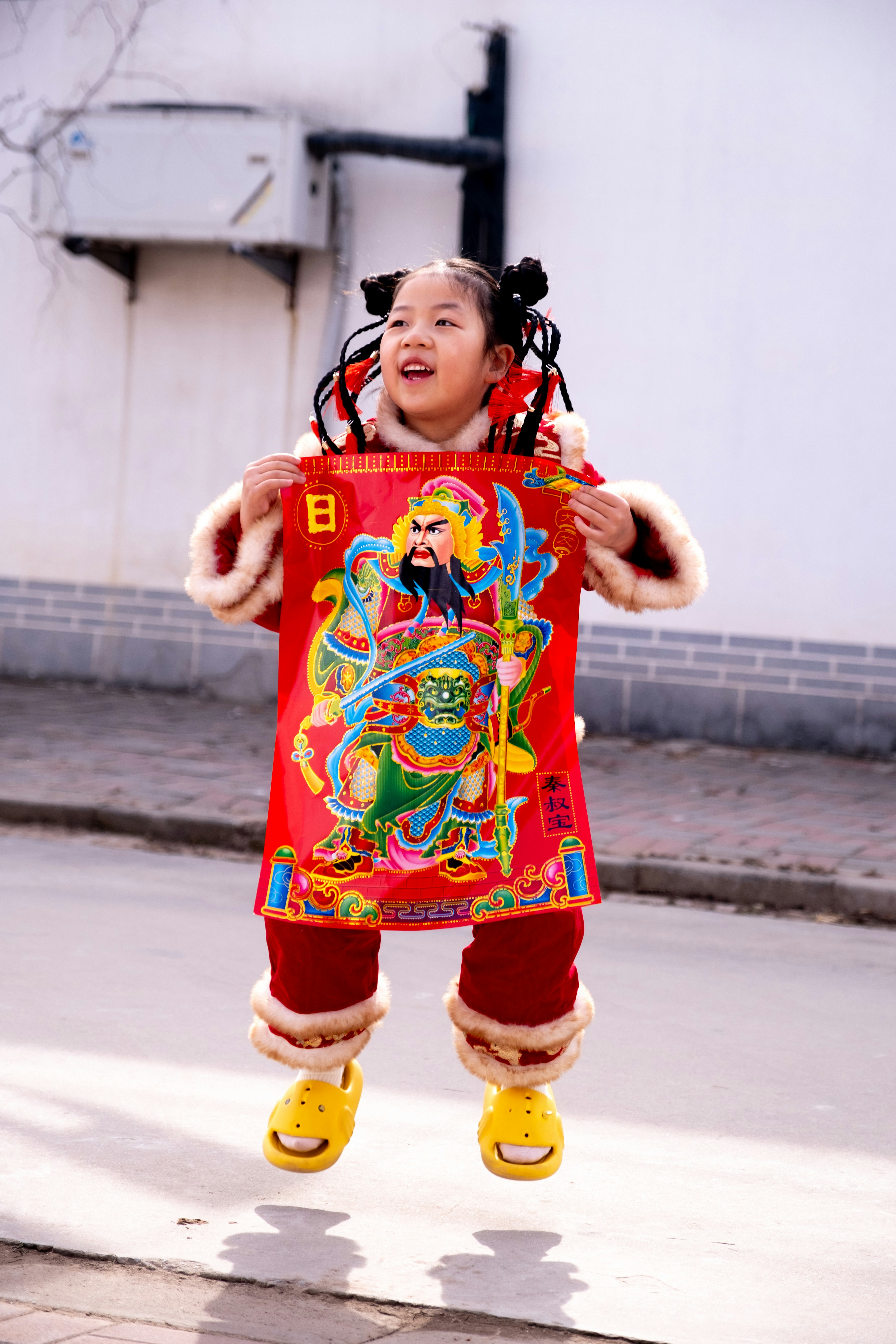Joyful Lunar New Year Cheer: Girl in Red with Festive Banner