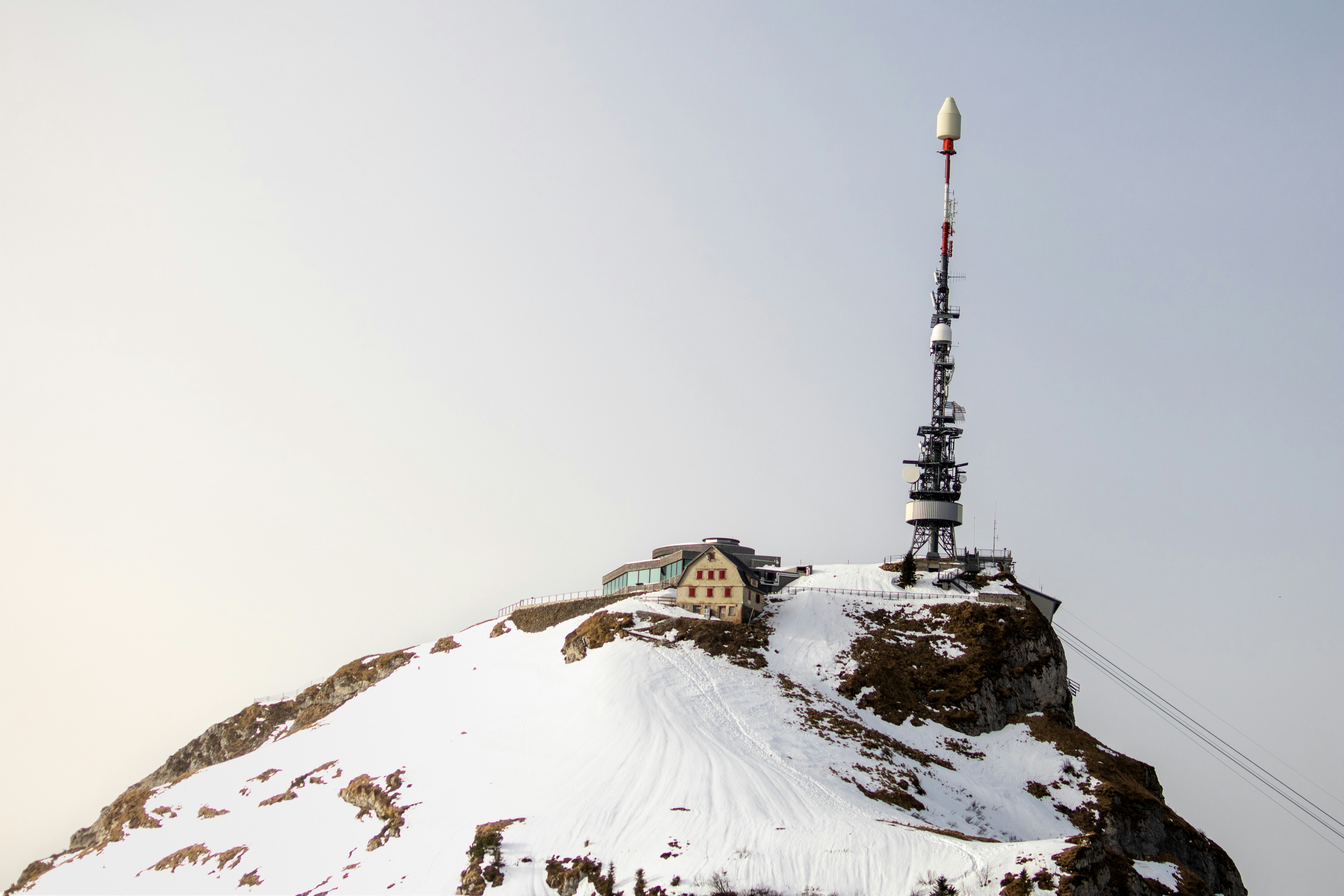 Antenna Summit: Snow-Capped Outpost Against a Pale Sky