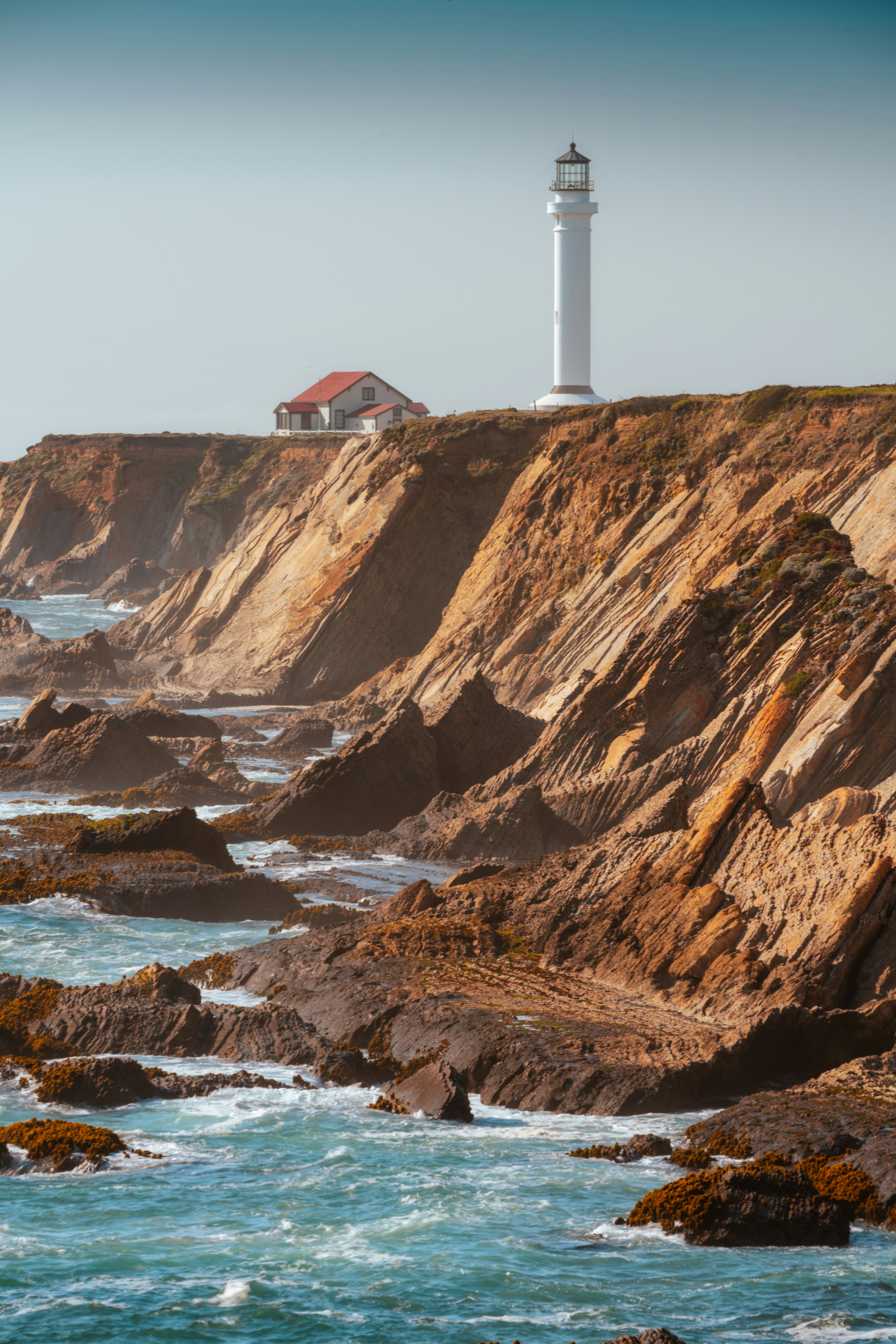 Lighthouse Crest: A White Beacon Standing Above Rugged Cliffs