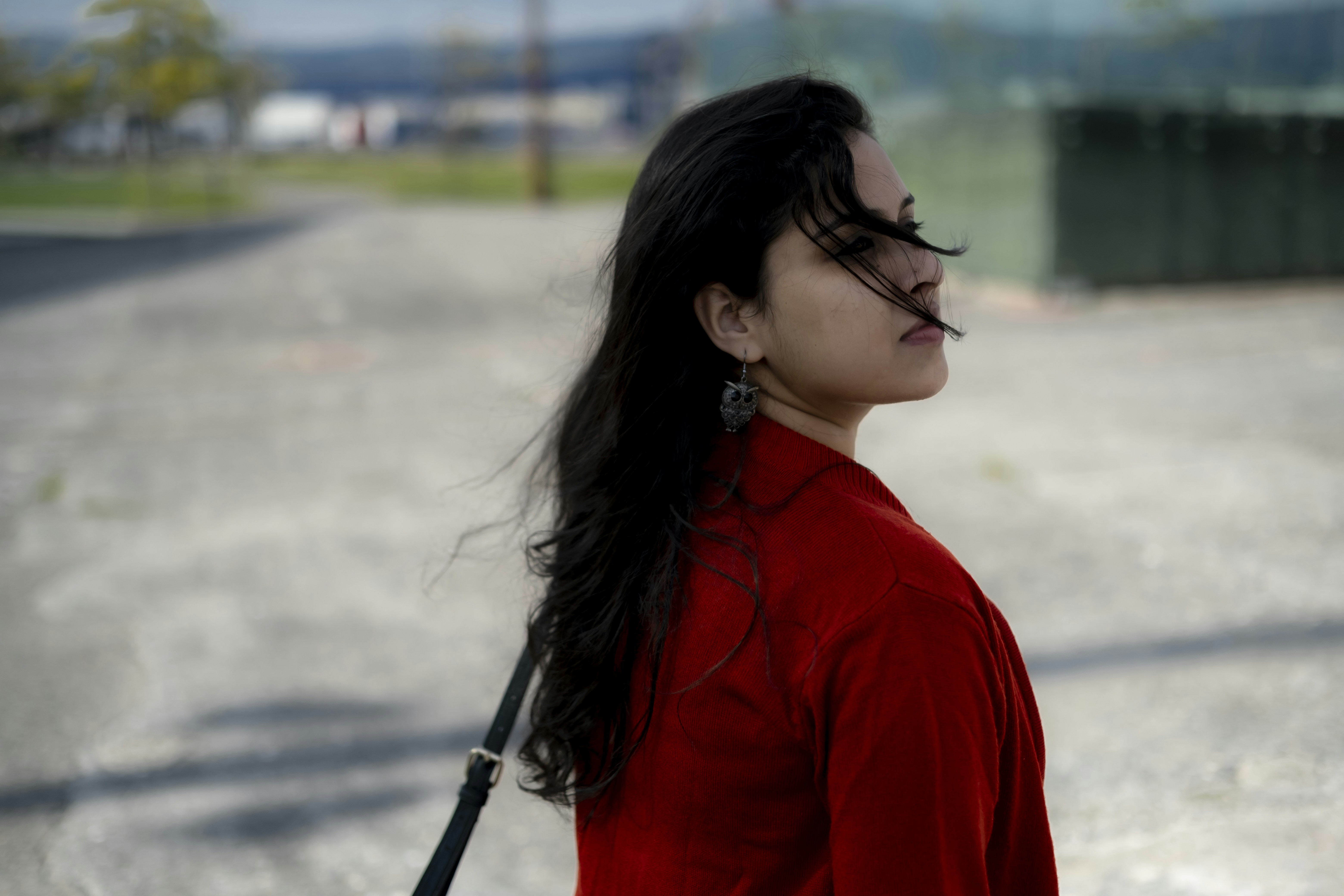 Red Coat, Wind-Swept Portrait on a Quiet Ave