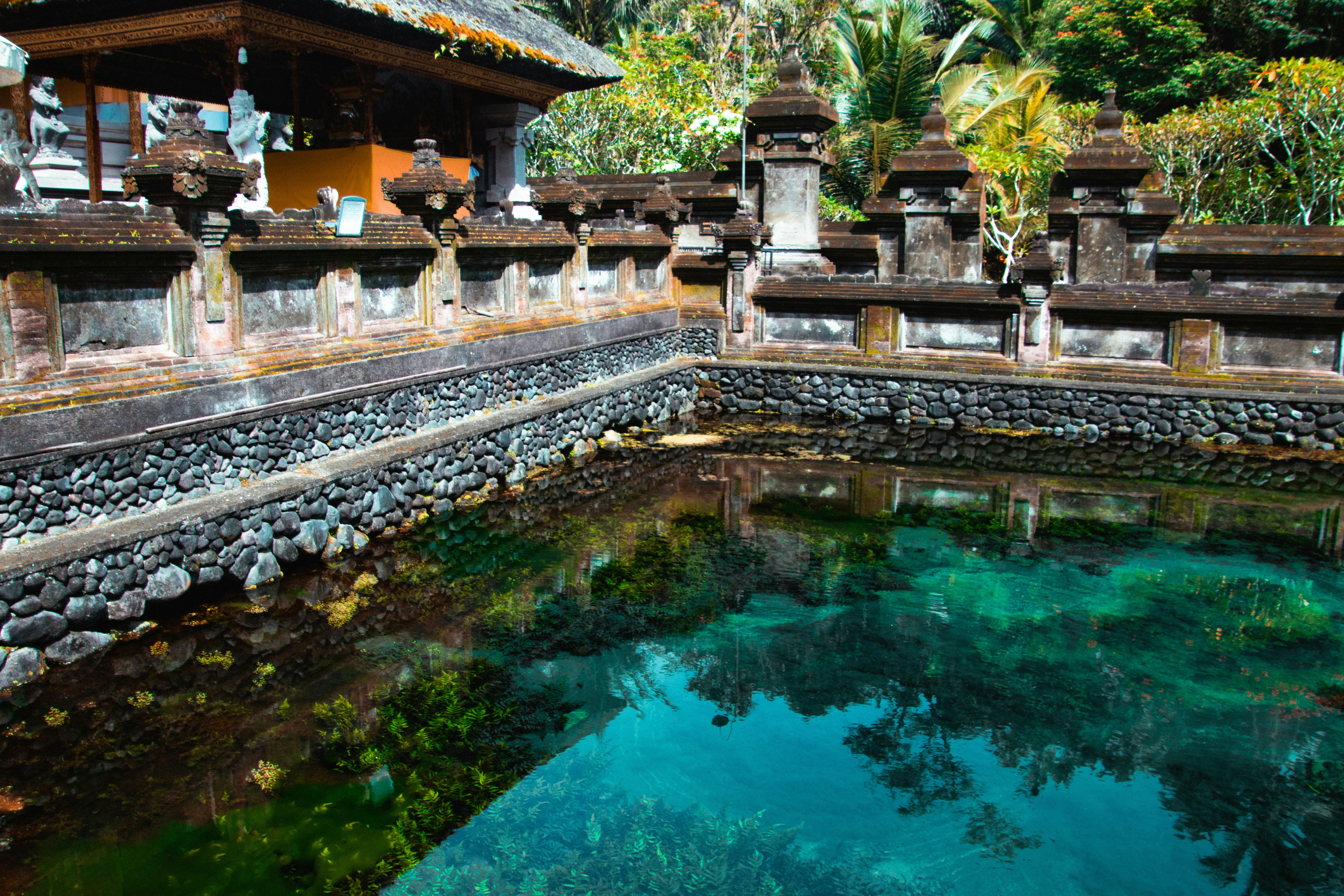 Tranquil temple pool framed by stone balustrades and turquoise water