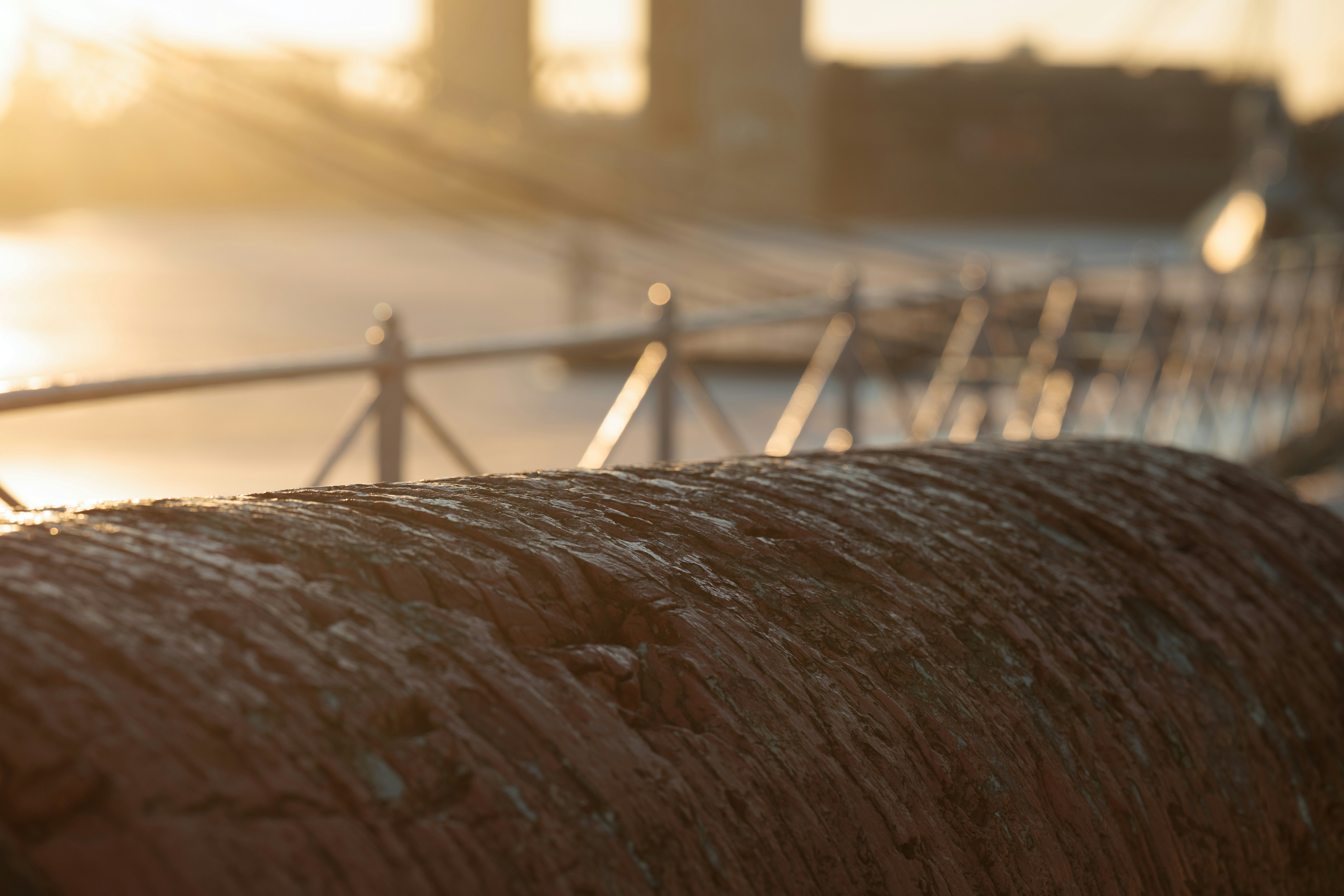 Sunlit Railing and Weathered Arc: A Quiet Riverside View