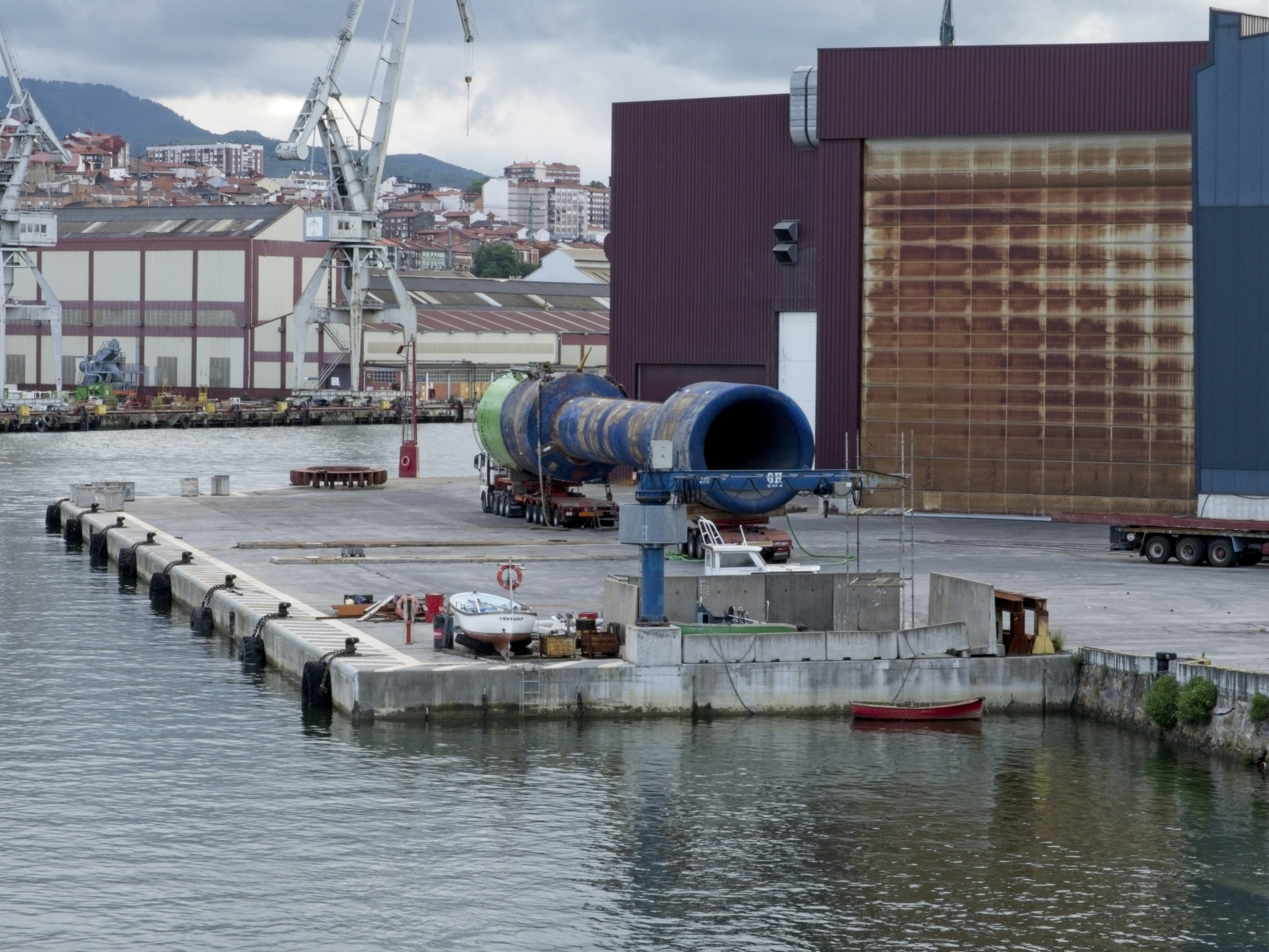 Blue Industrial Pipe Arc Anchored at the Dock