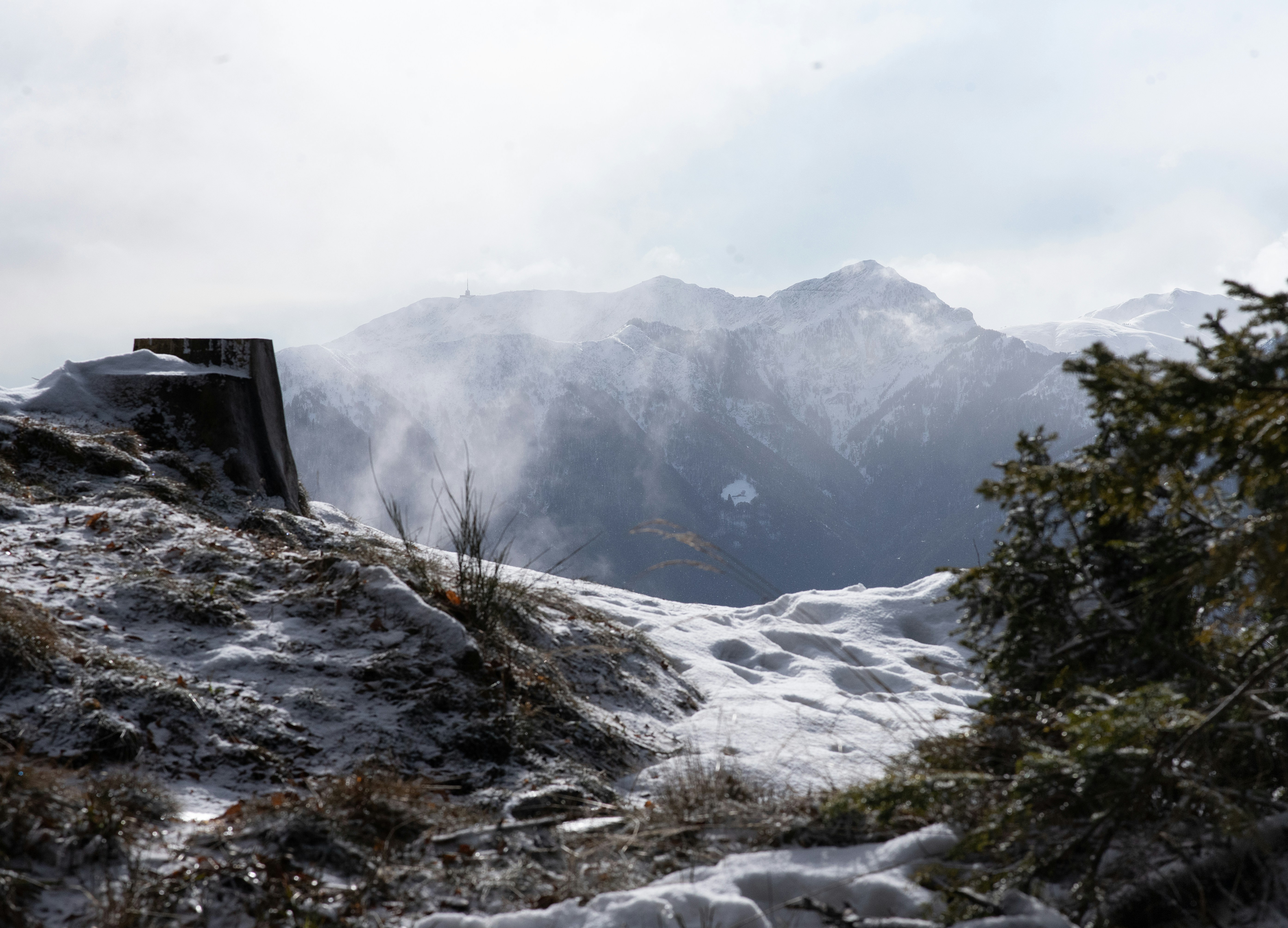 Snow-Scoured Ridge Beneath Snow-Capped Peaks