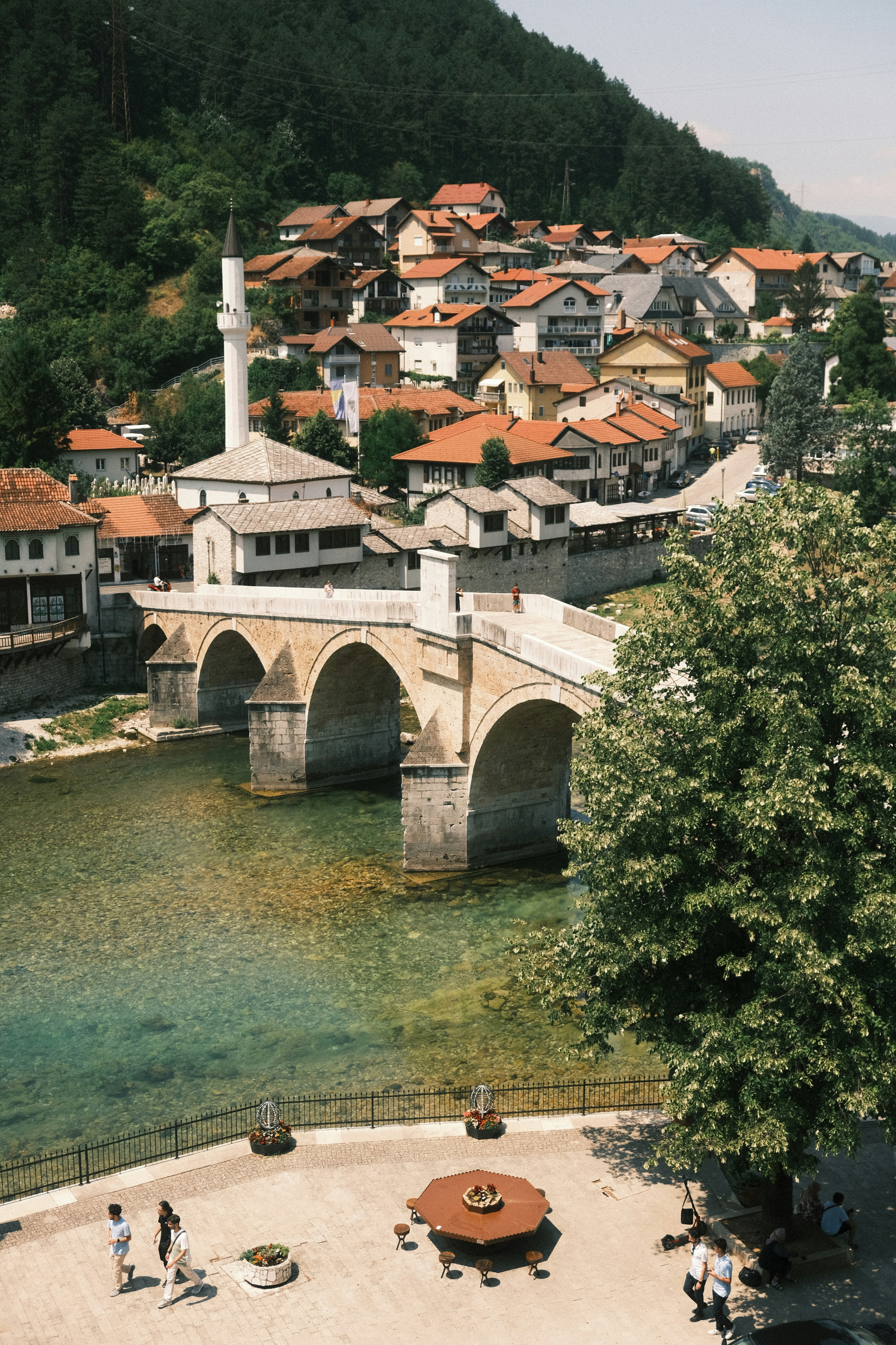 Stone Archways Over Tranquil River: A Balkan Village Snapshot