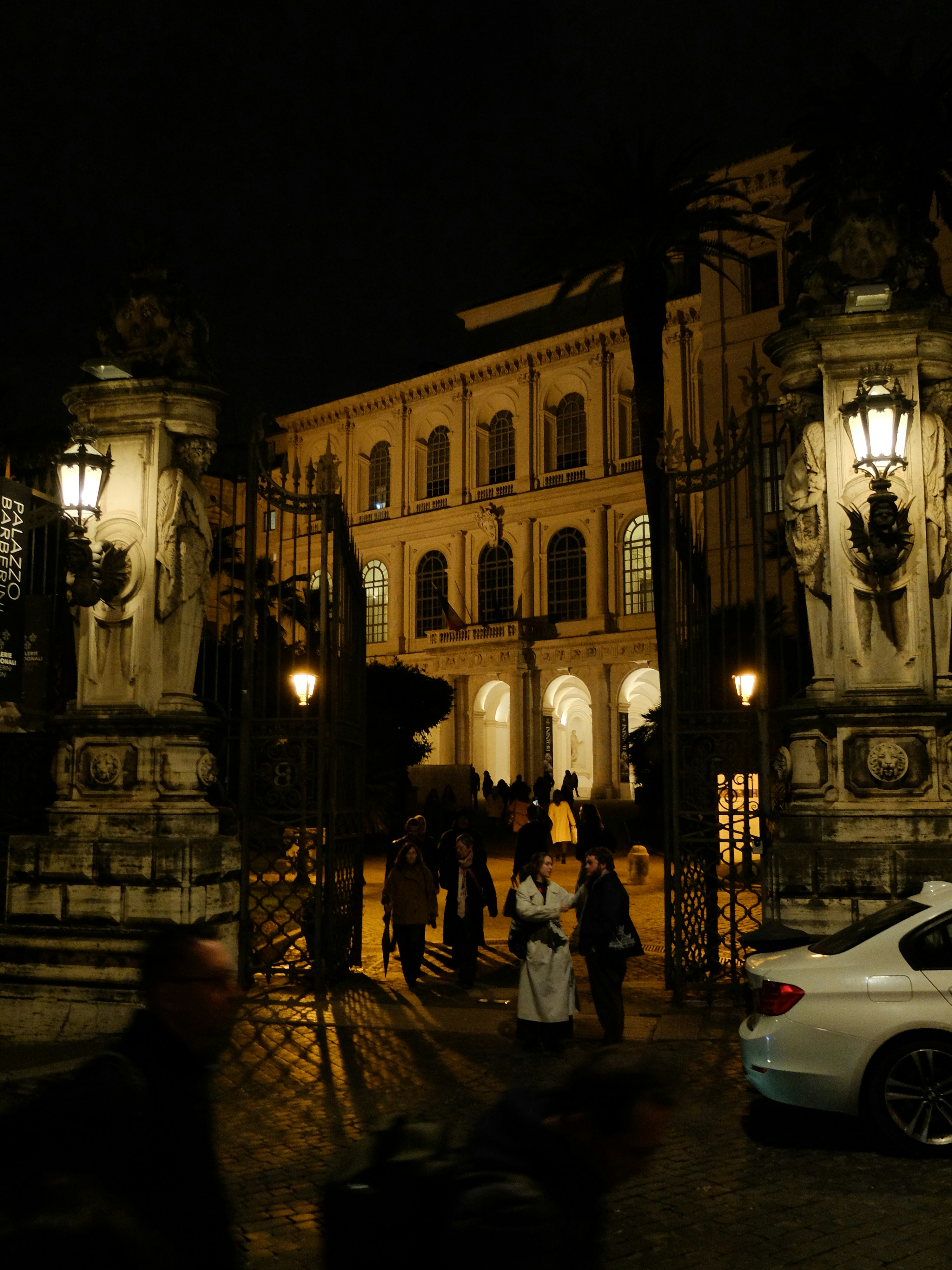 Gilded Gatehouse Evening: Lanterns Illuminate a Historic Courtyard