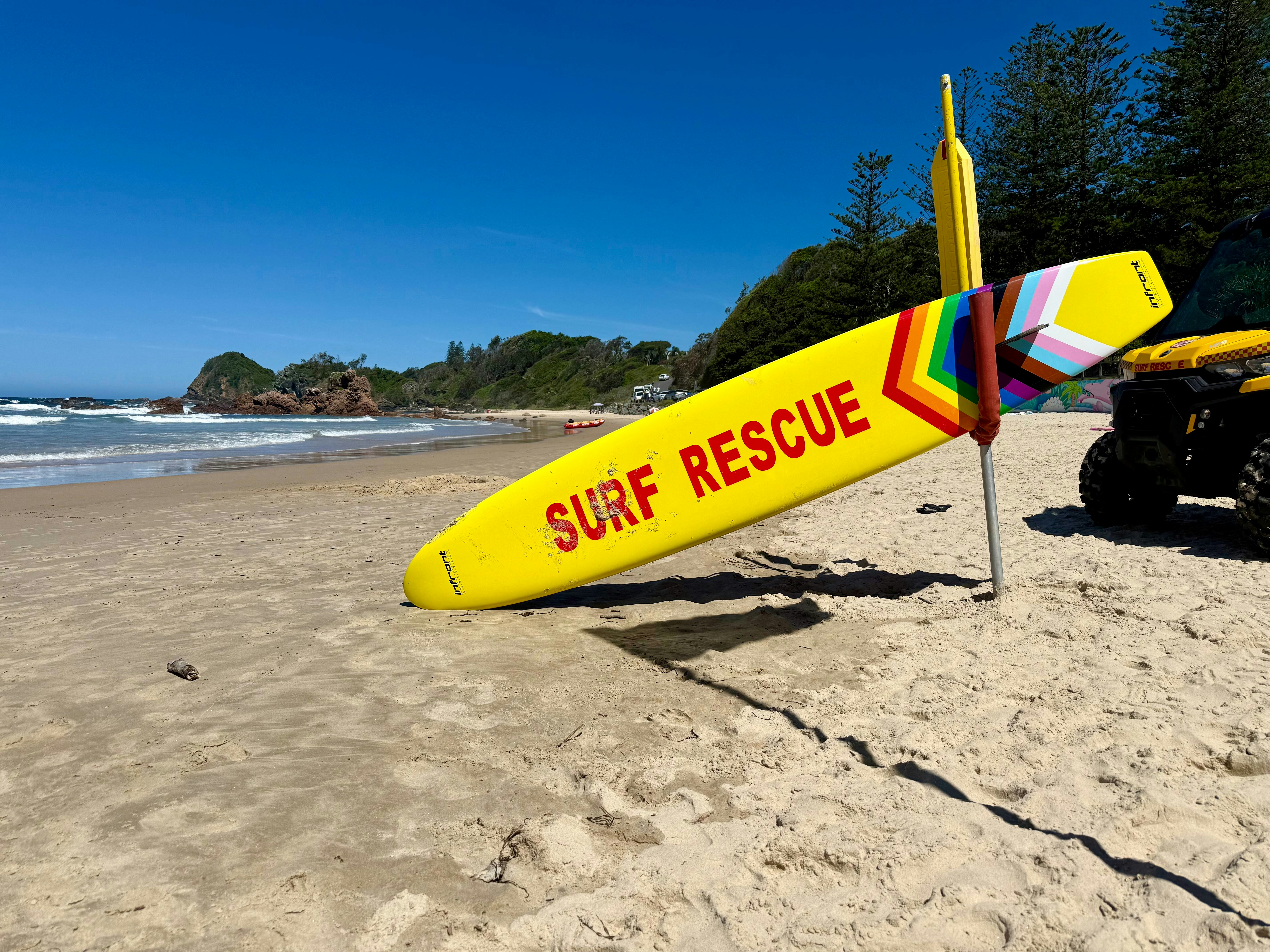 Bright Surf Rescue Board Reposed on a Golden Beach