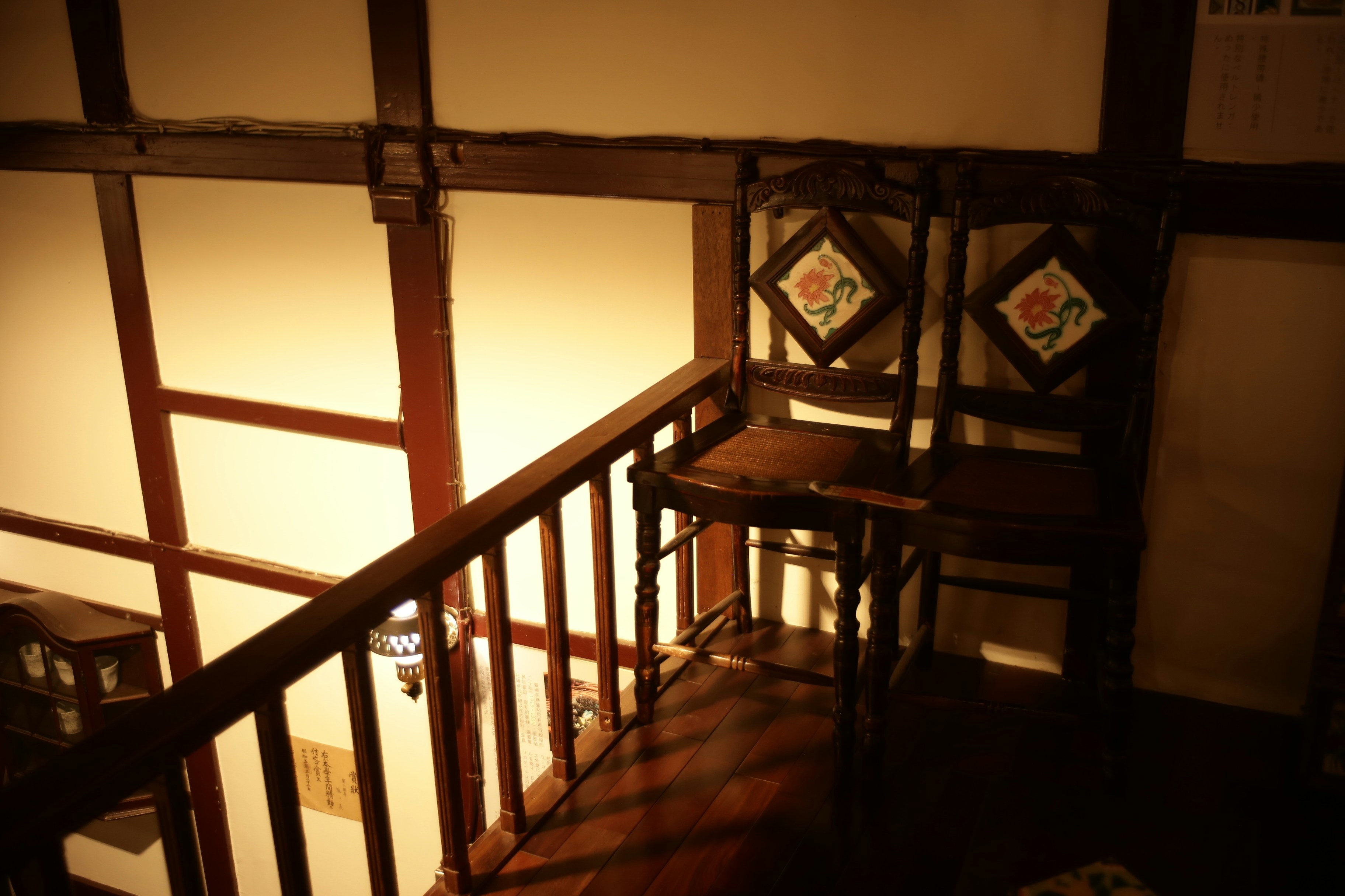 Dim Balcony Corner with Ornate Chairs in Warm Glow