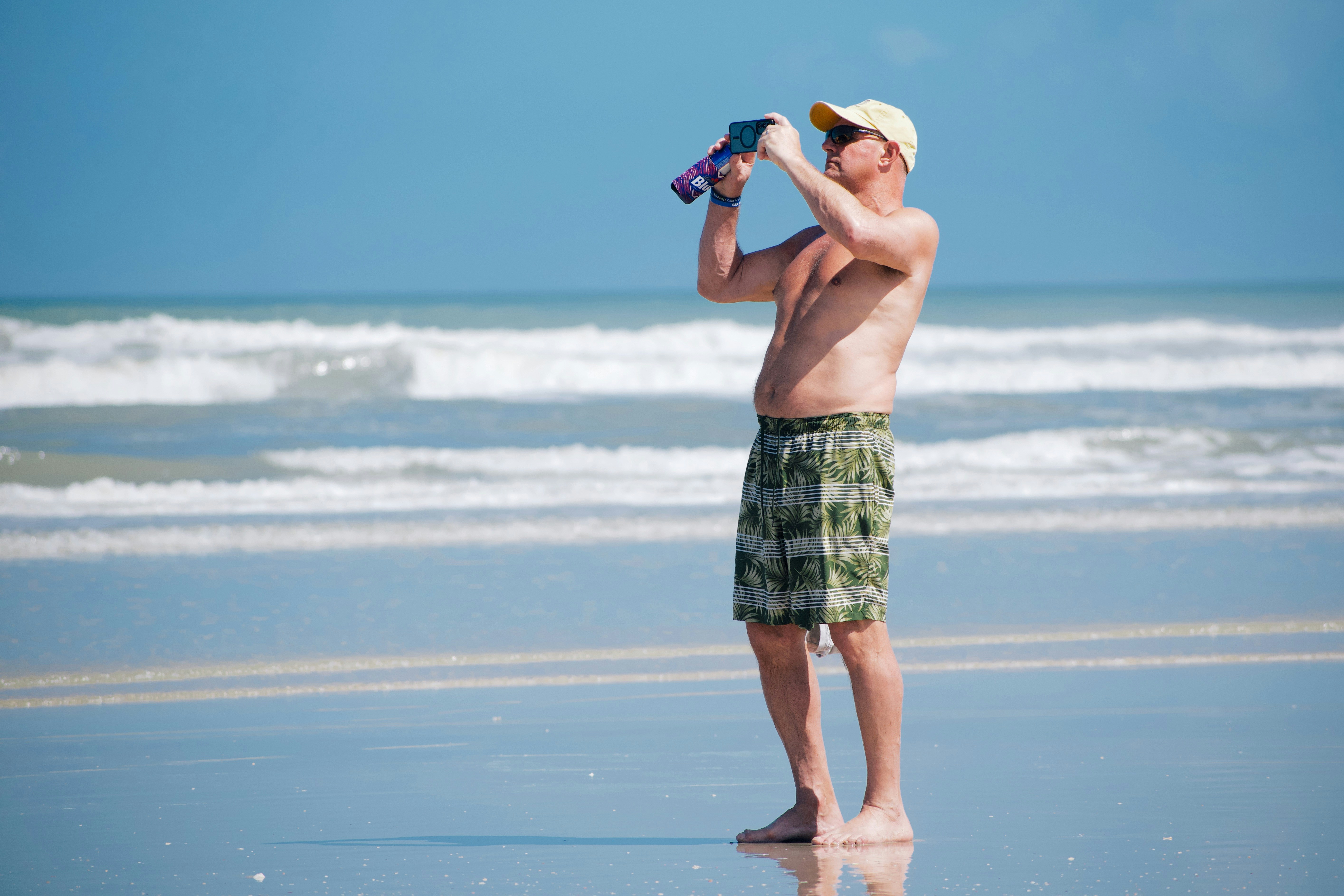 Sunlit Pose: Man Captures Moment on a Quiet Beach