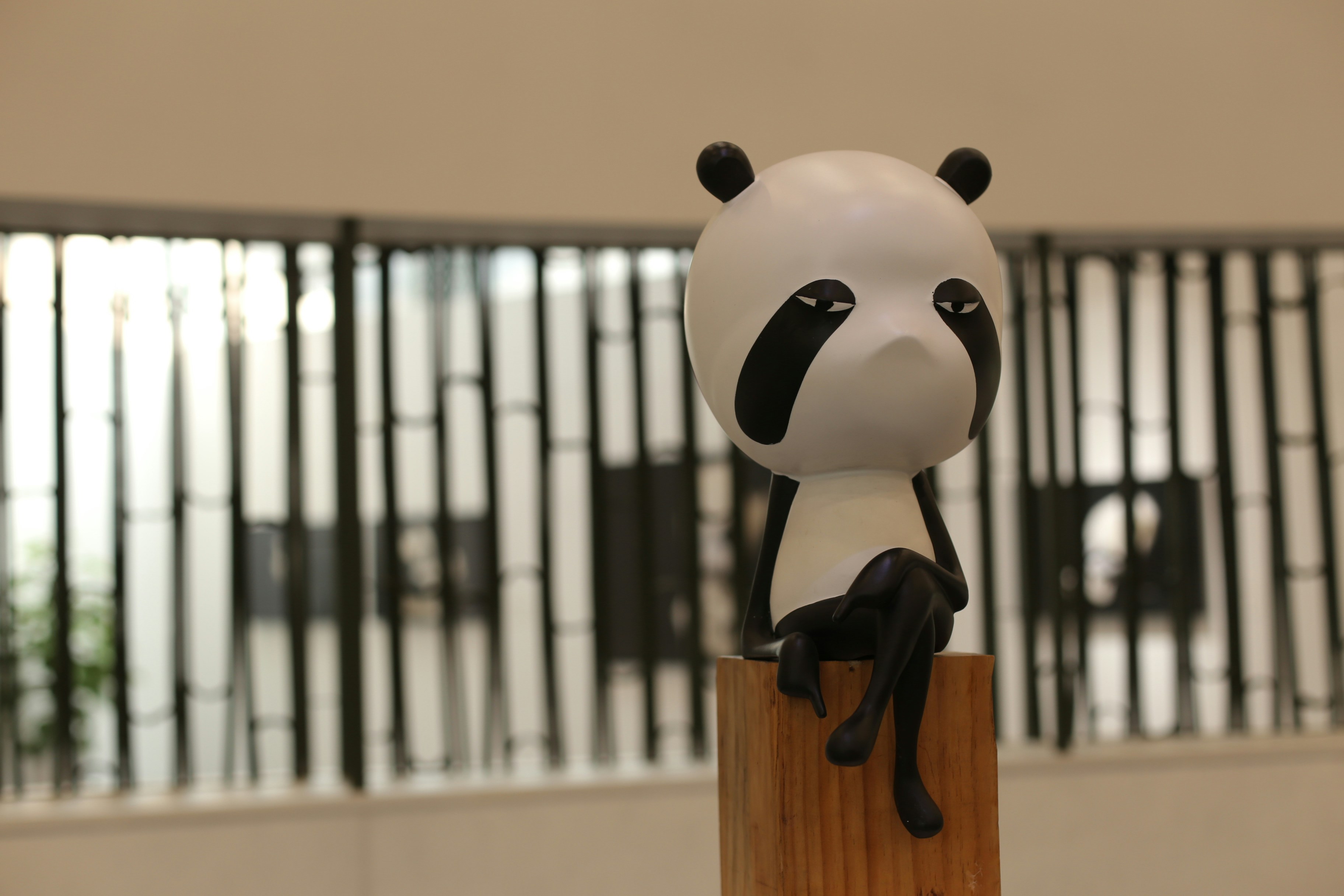 Panda on a Post: Solo Figure in a Quiet Gallery