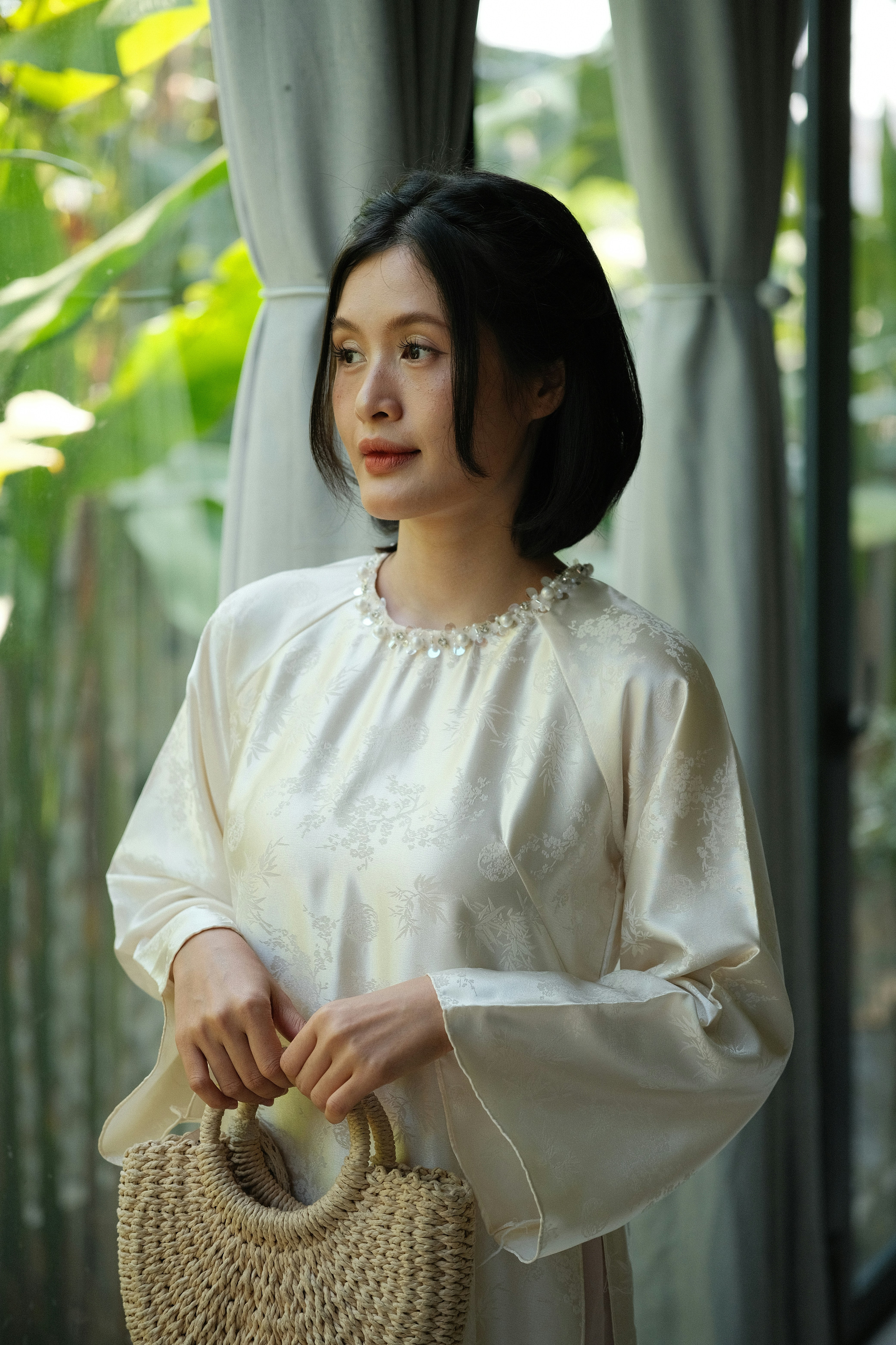Elegance in Silk: Soft Portrait by the Balcony Curtain
