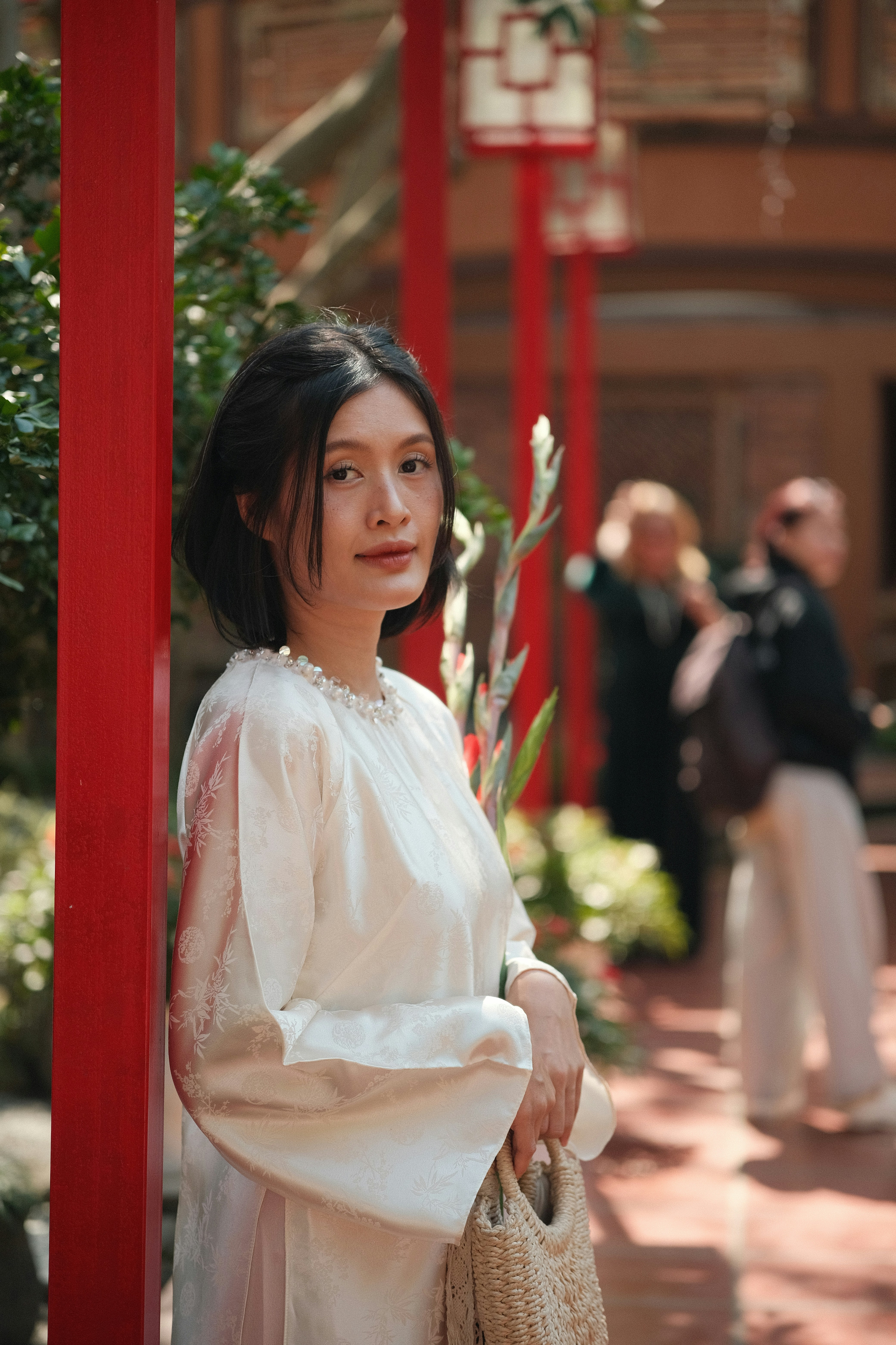 Portrait in Red Columns: Soft Light on a Quiet Moment