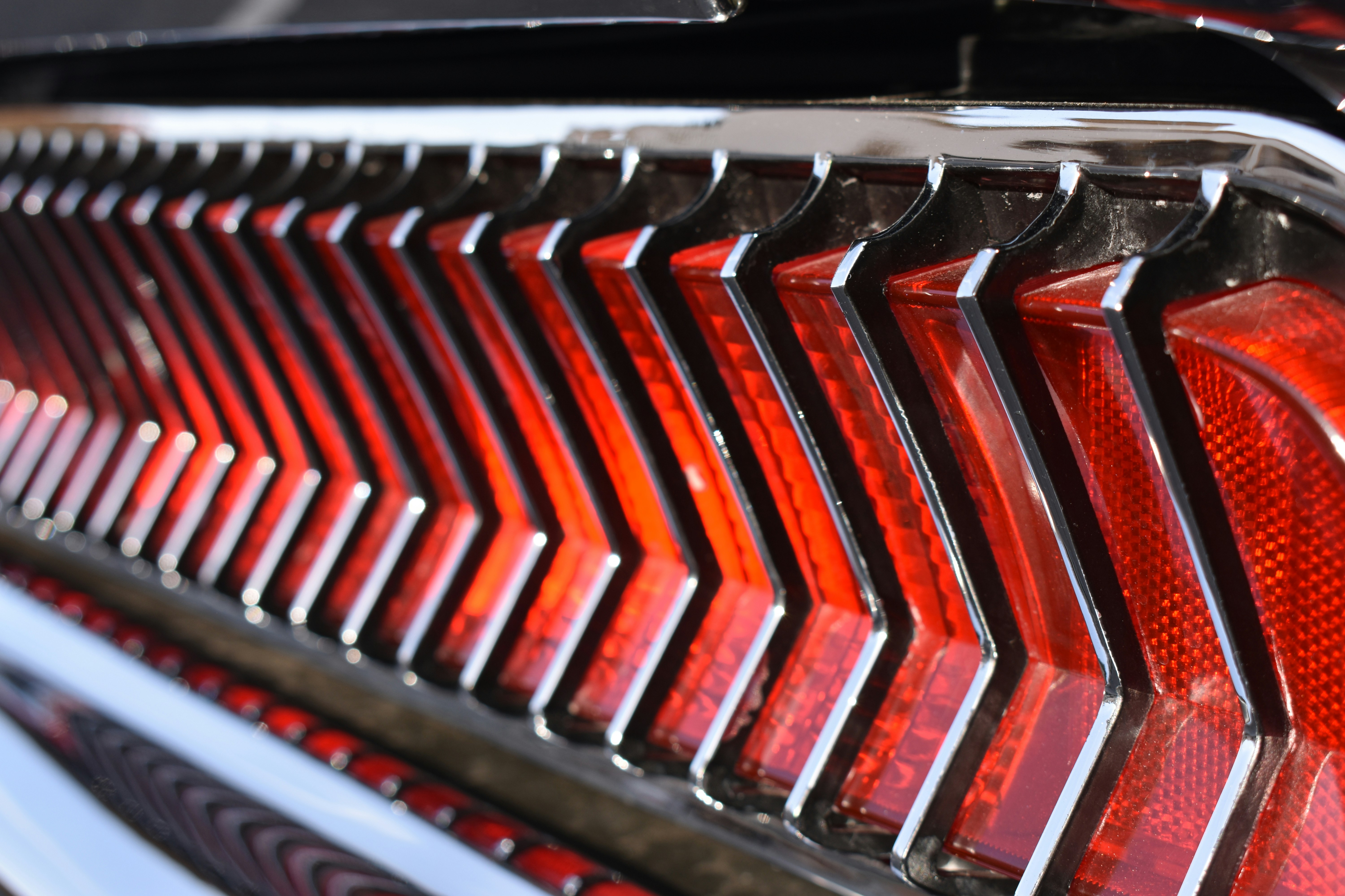 Chrome Chevron Echo: Tail Light Ridges in Red and Black