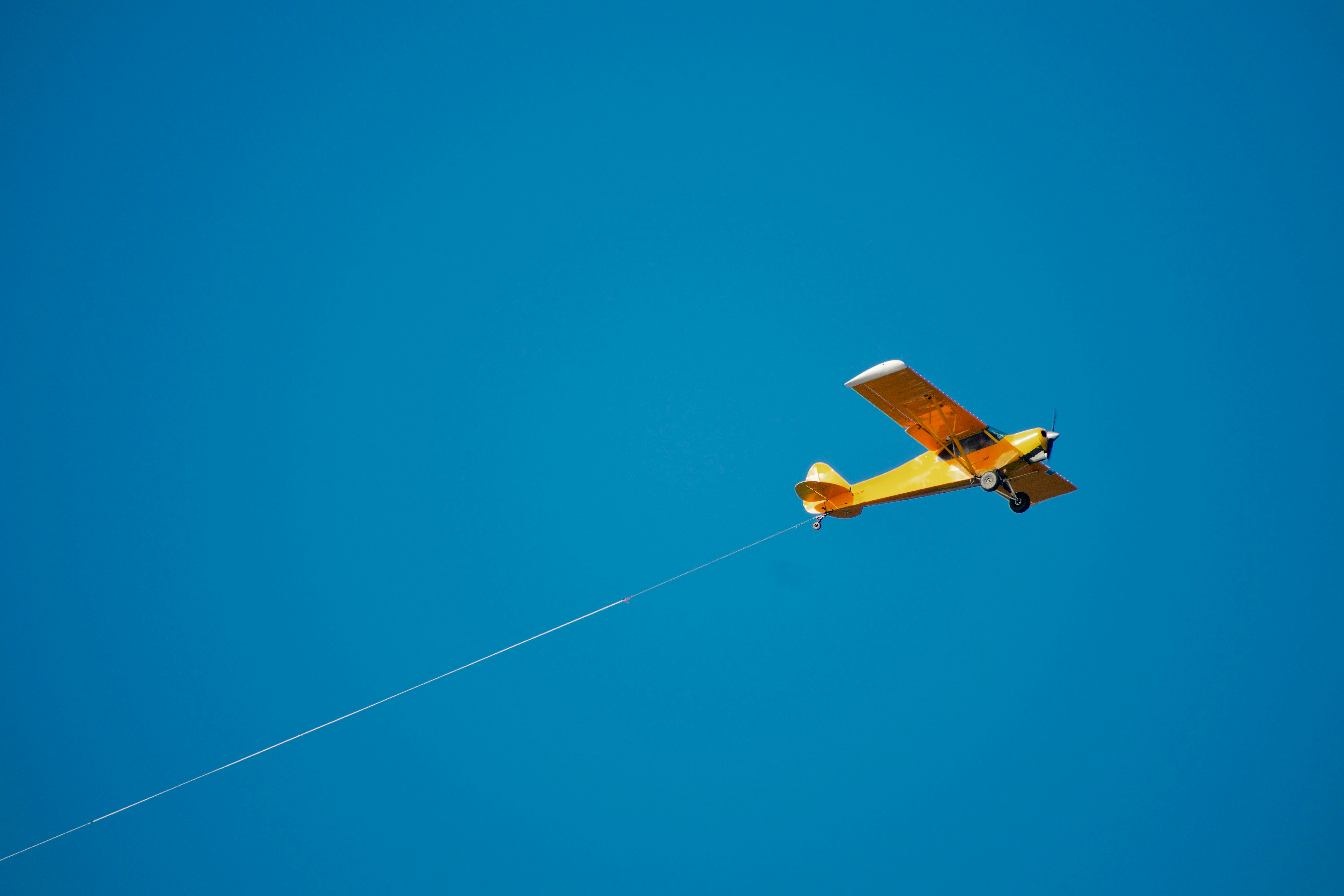 Yellow Biplane Against a Clear Blue Sky