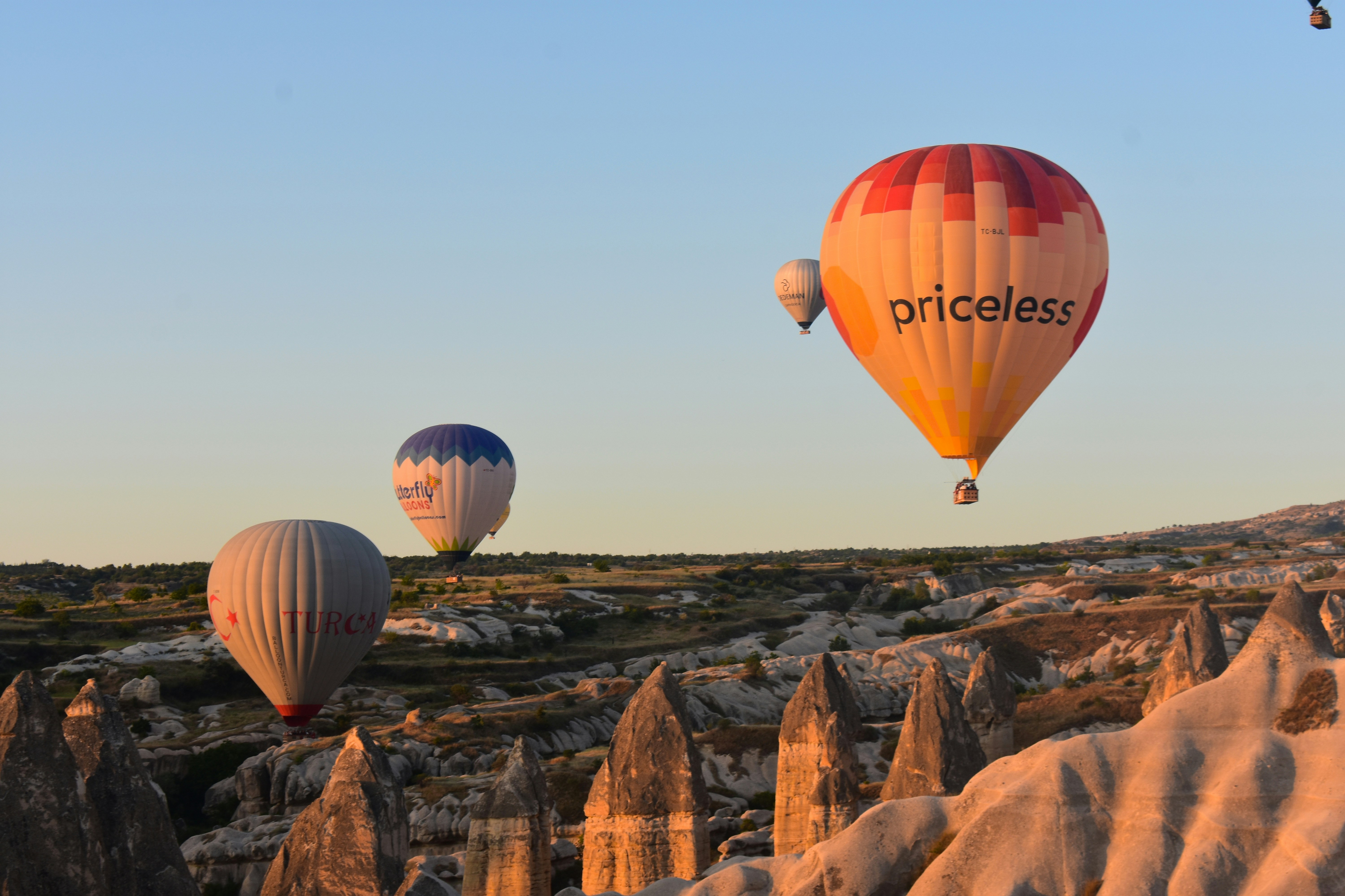 Floaters Over Carved Stone: Hot Air Balloons Treading a Dune Nightscape