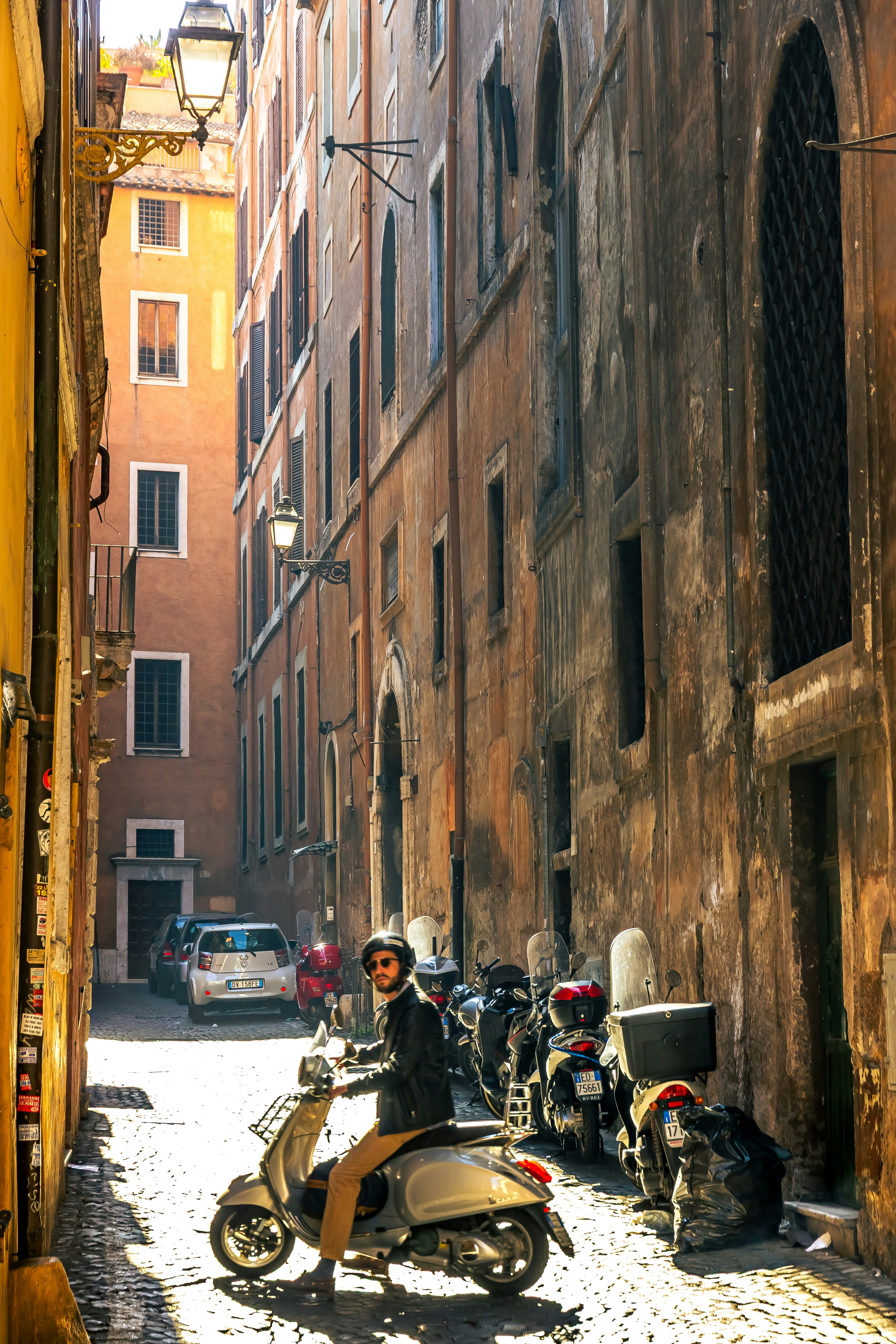 Scooter in a Sunlit Italian Alleyway