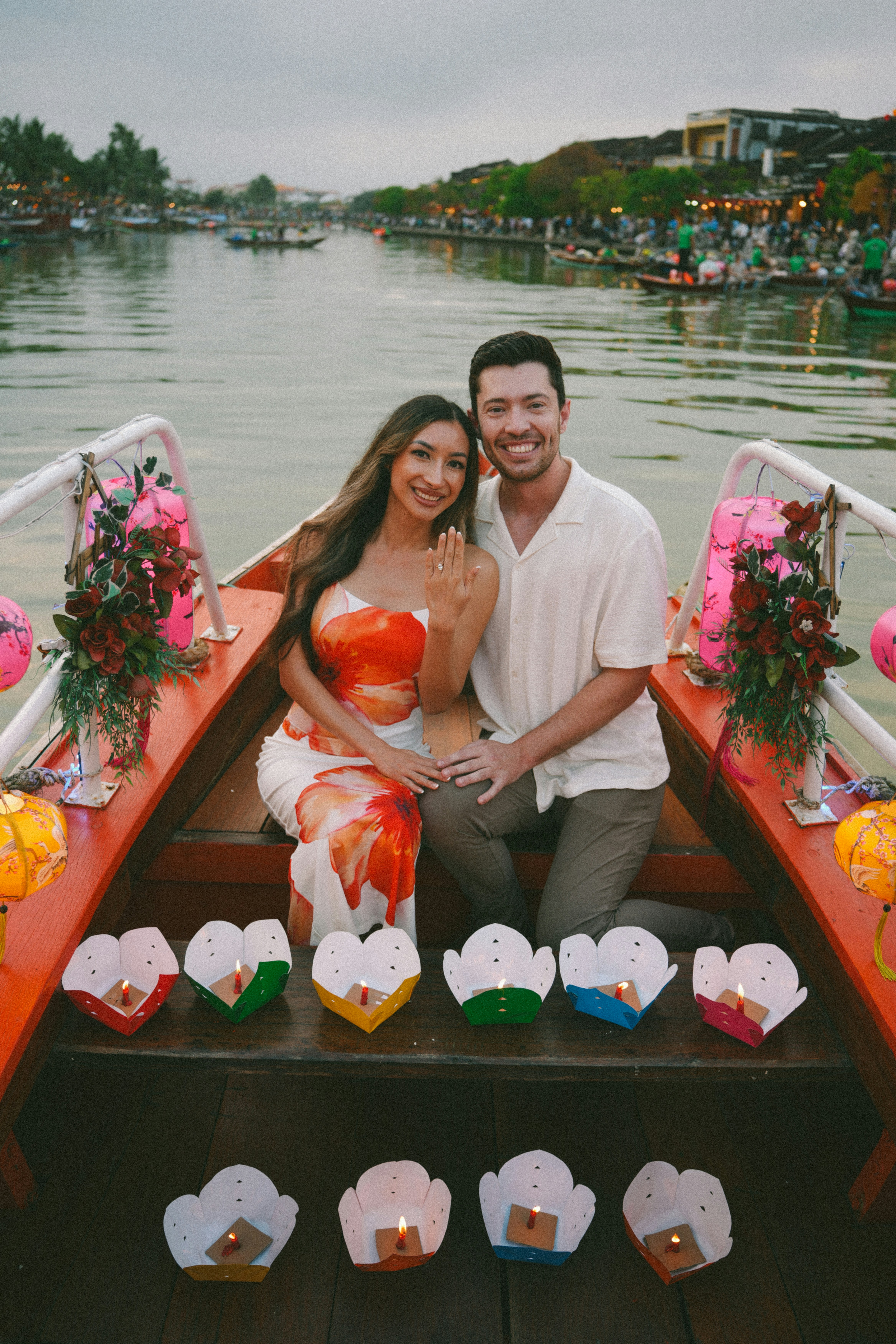 Couple in a vibrant boat wedding scene on the river at dusk